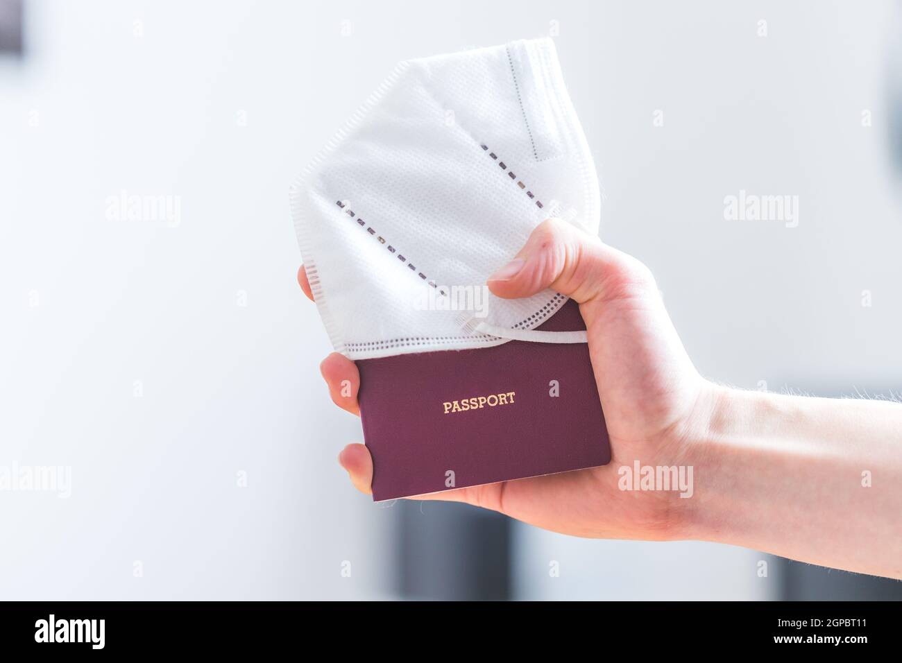 Close Up Of Fingers Holding A Passport For Travelling Airport