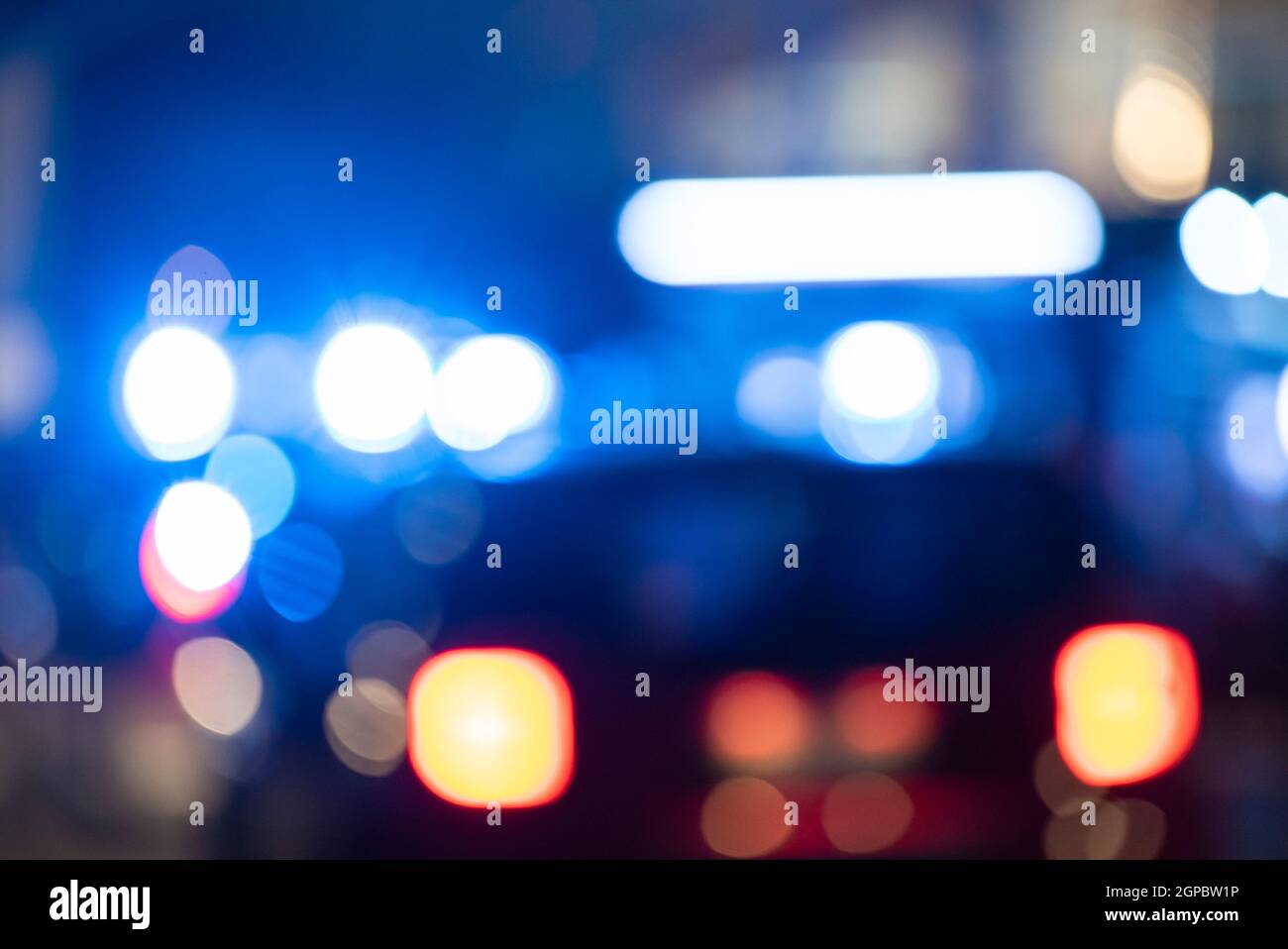 Detail of Blurred emergency background with blue lights in the city at ...