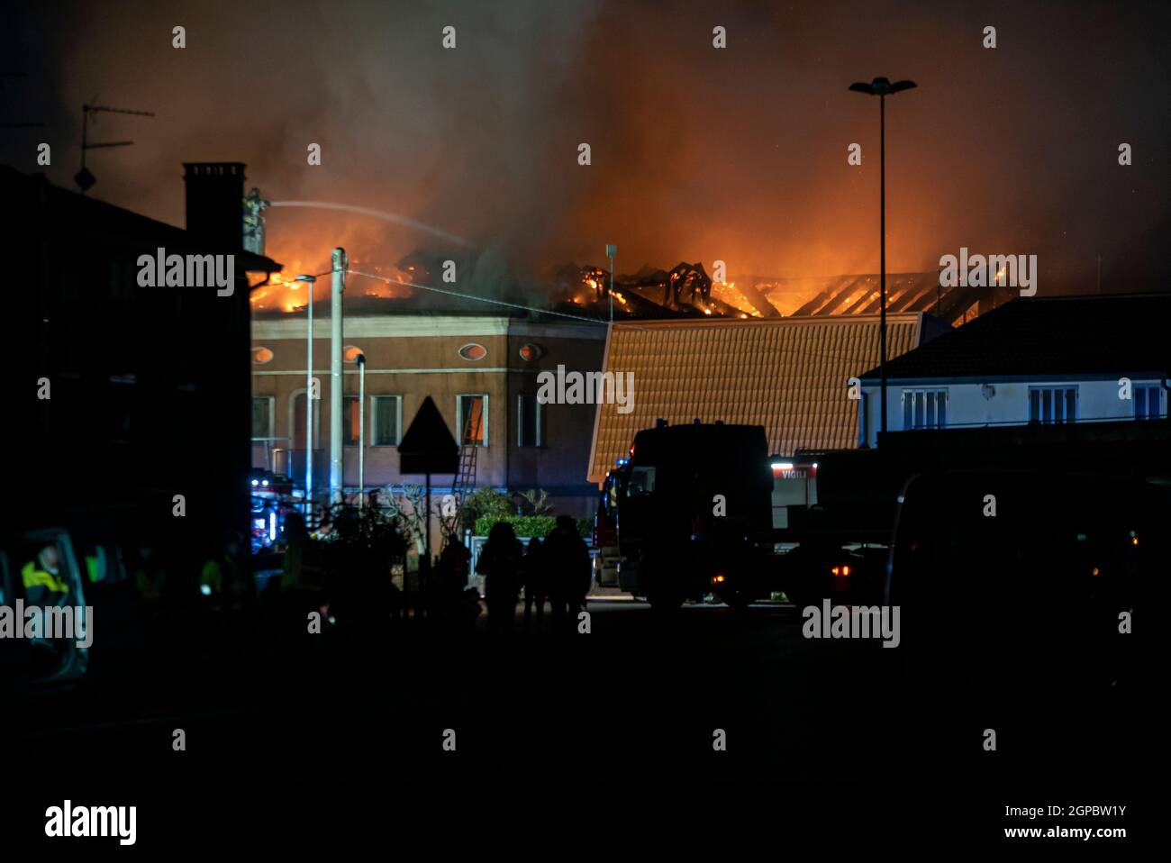 House burning at night with firefighters and smoke Stock Photo - Alamy
