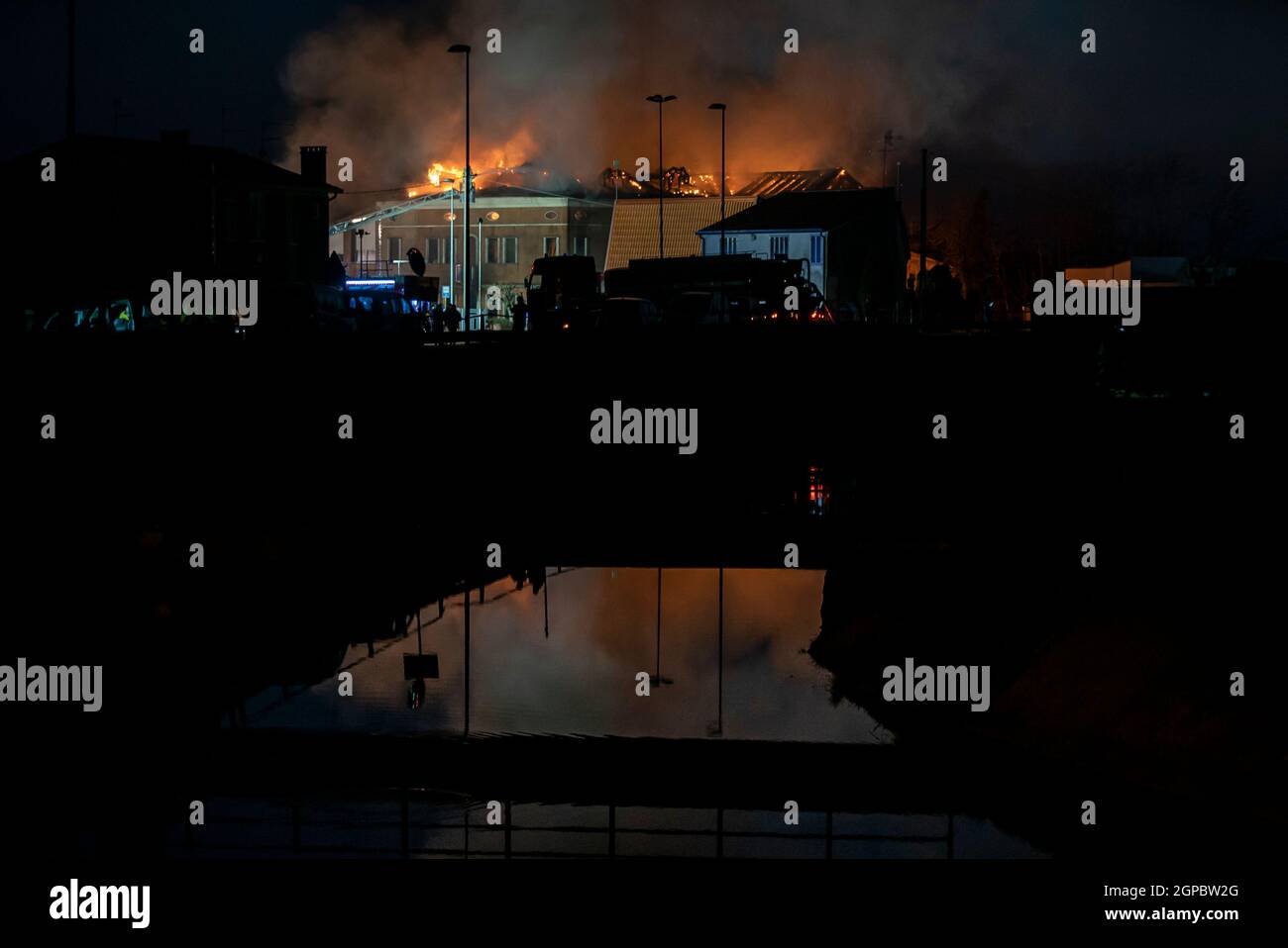 House burning at night with firefighters and smoke Stock Photo - Alamy