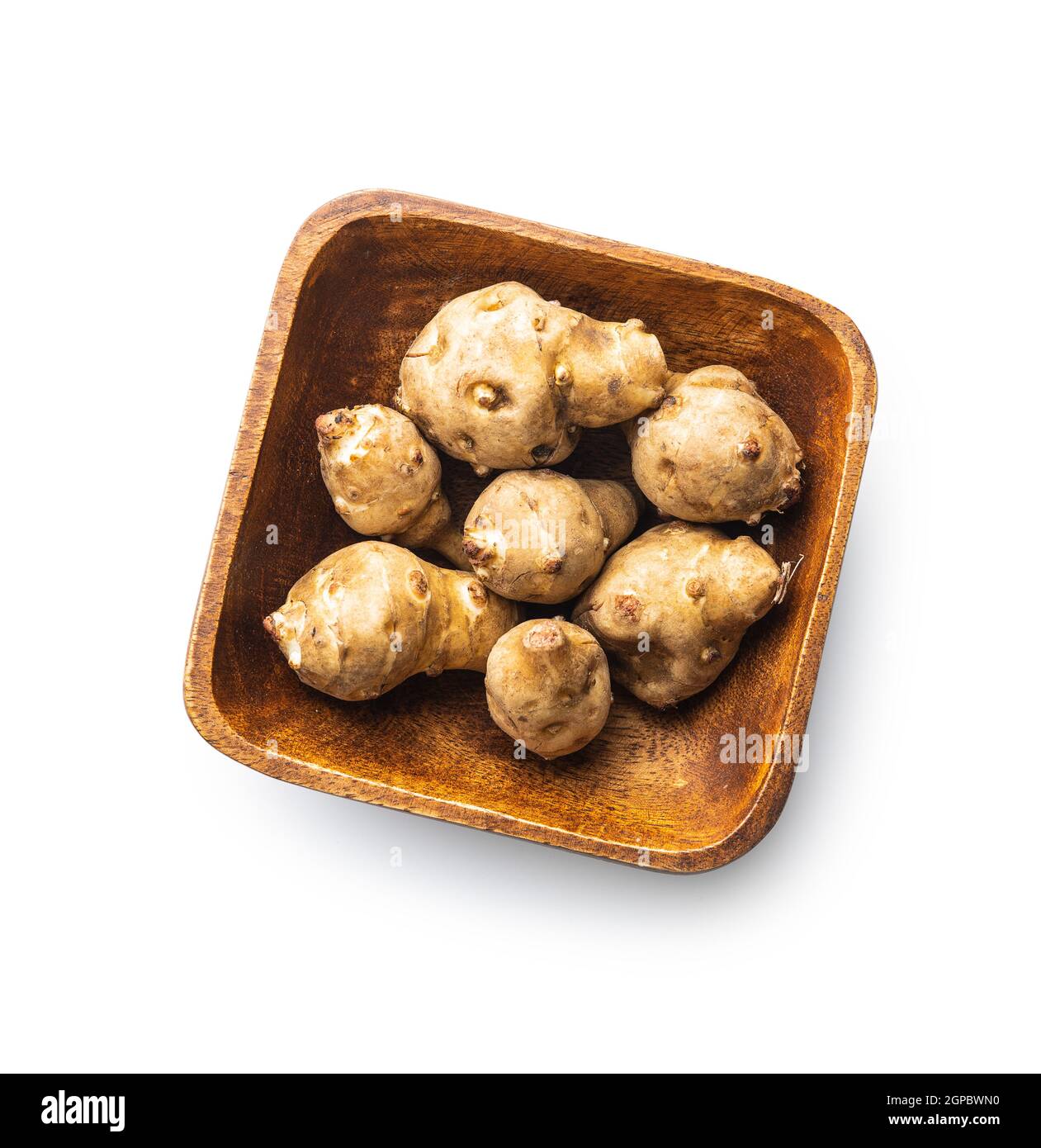 Raw jerusalem artichoke in wooden bowl. Topinambur vegetable root ...