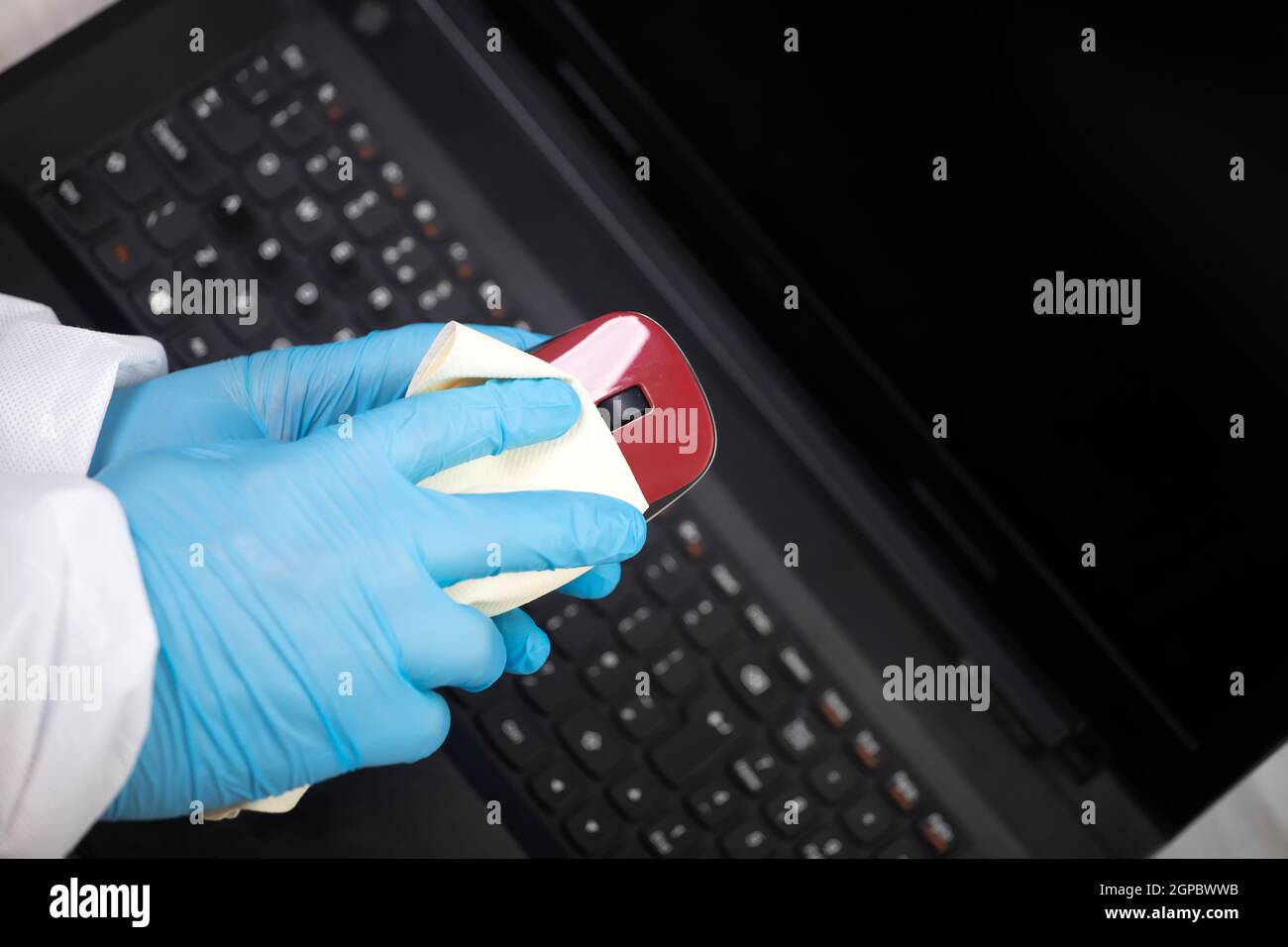 Office sanitizing wiping mouse with disinfectant. Coronavirus COVID-19 ...