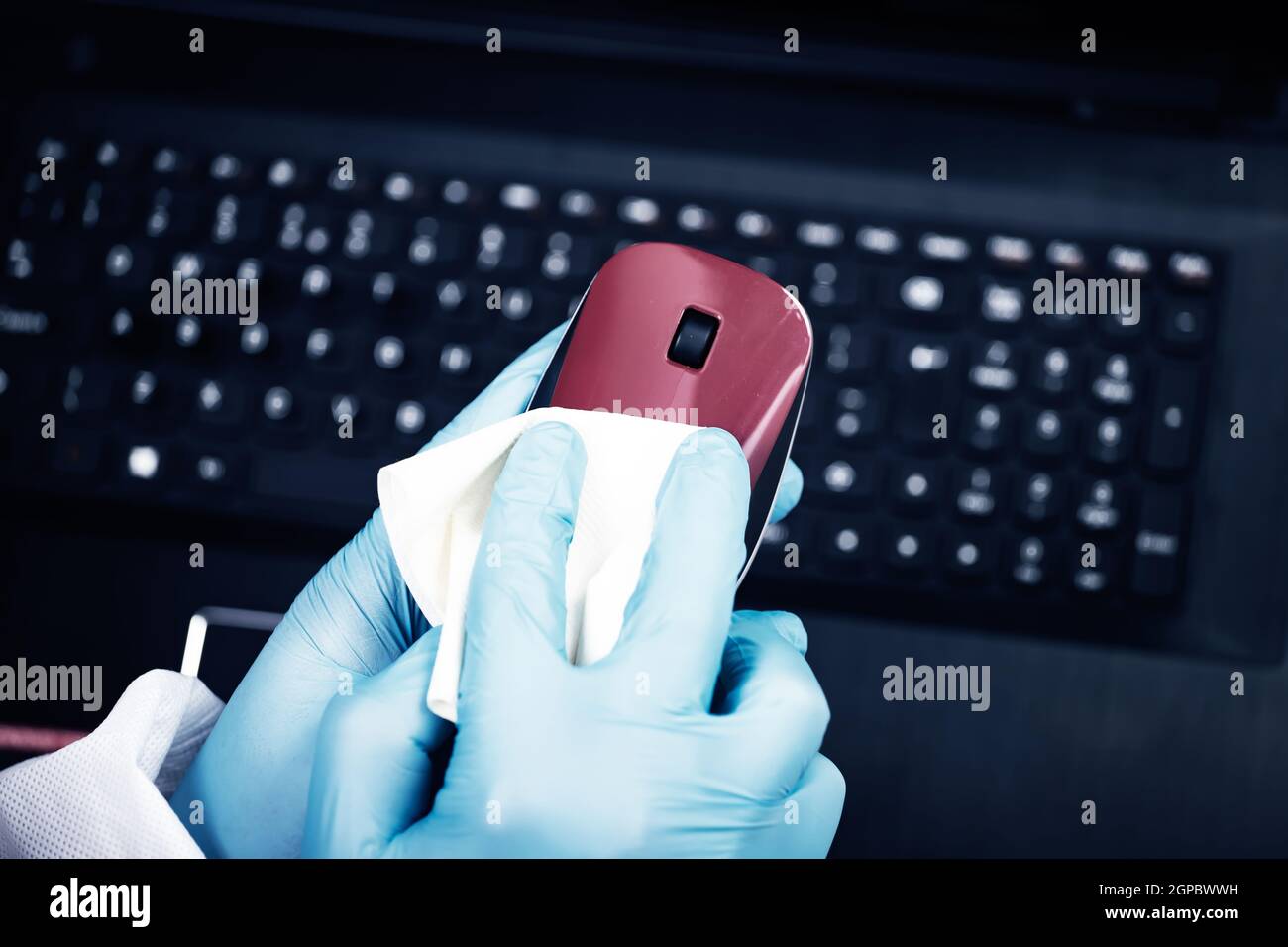 Office sanitizing wiping mouse with disinfectant. Coronavirus COVID-19 ...