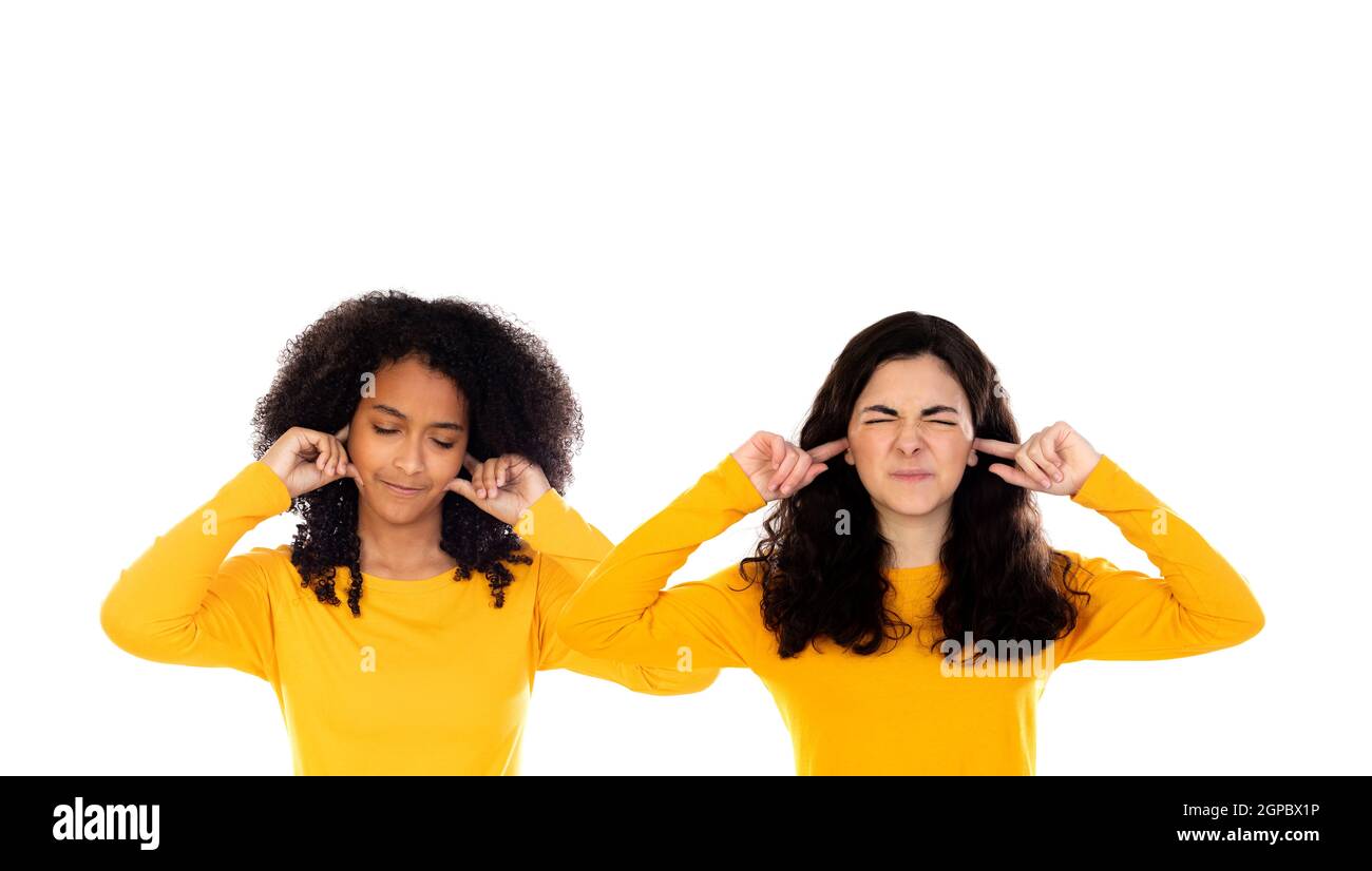 Two teenager girls covering her ears isolated on a white background ...