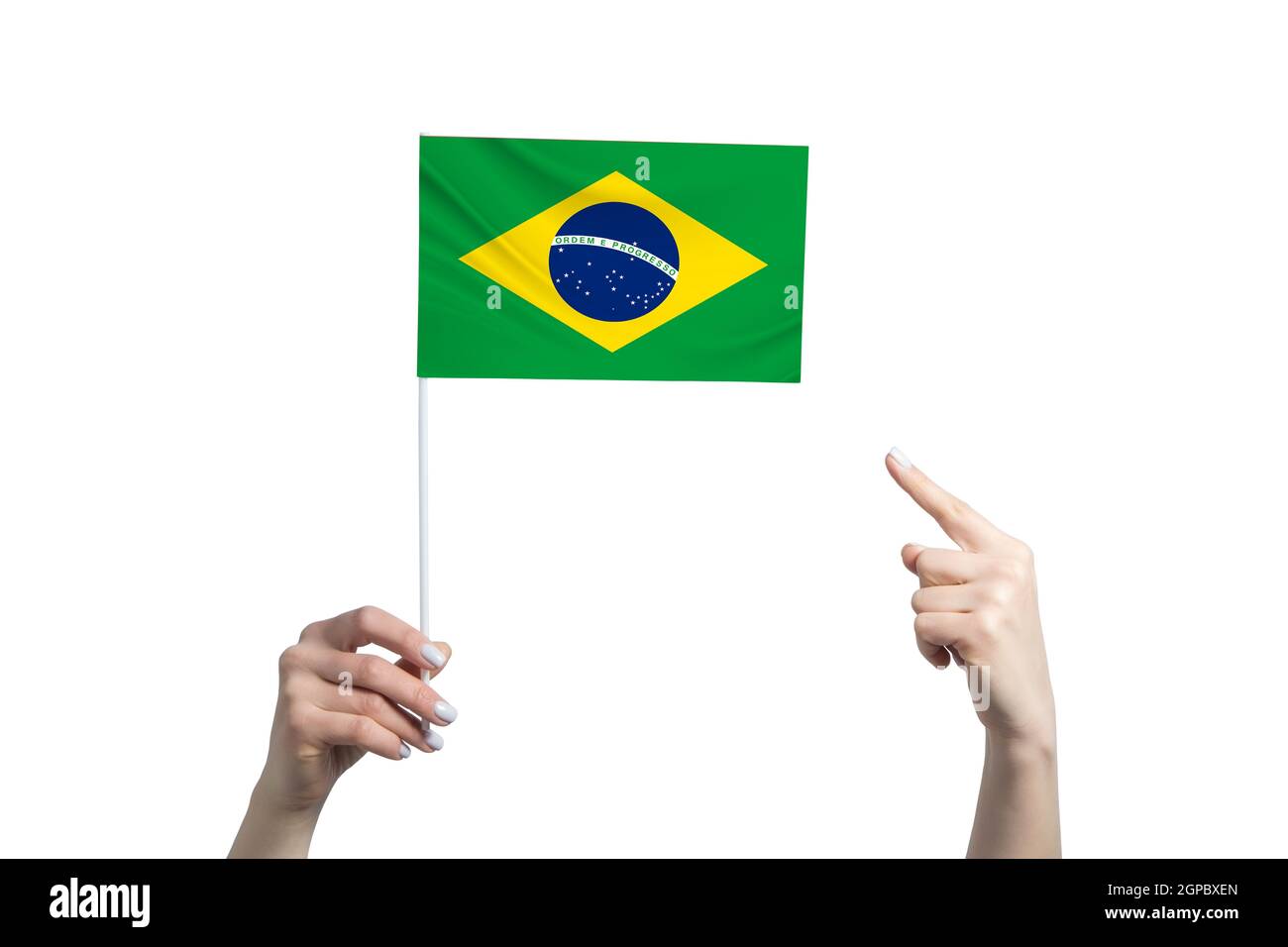 A beautiful female hand holds a Brazil flag to which she shows the ...
