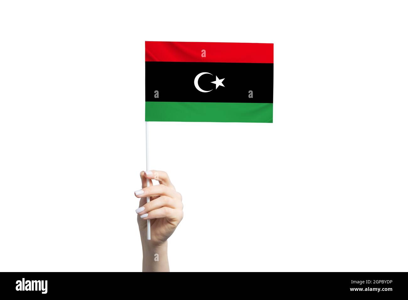 Beautiful female hand holding Libya flag, isolated on white background ...