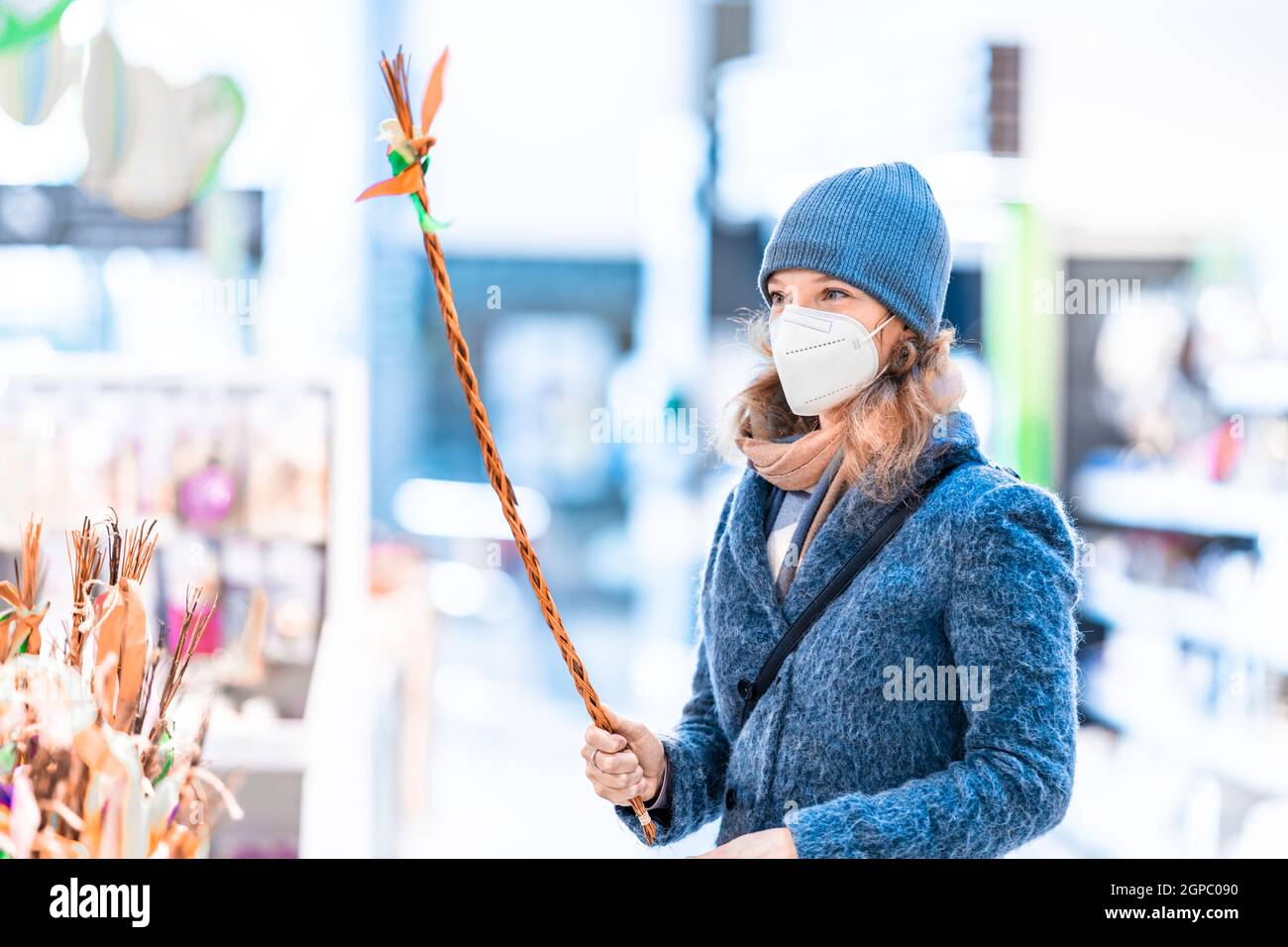 Easter rod in the hand of a young woman in the store Stock Photo - Alamy
