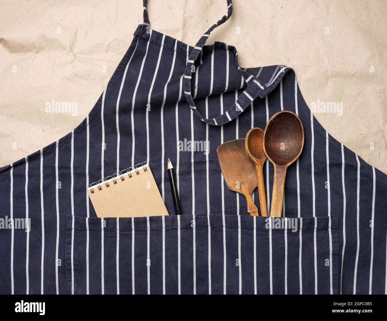 blue chef's apron, inside a pocket of wooden spoons, top view Stock ...