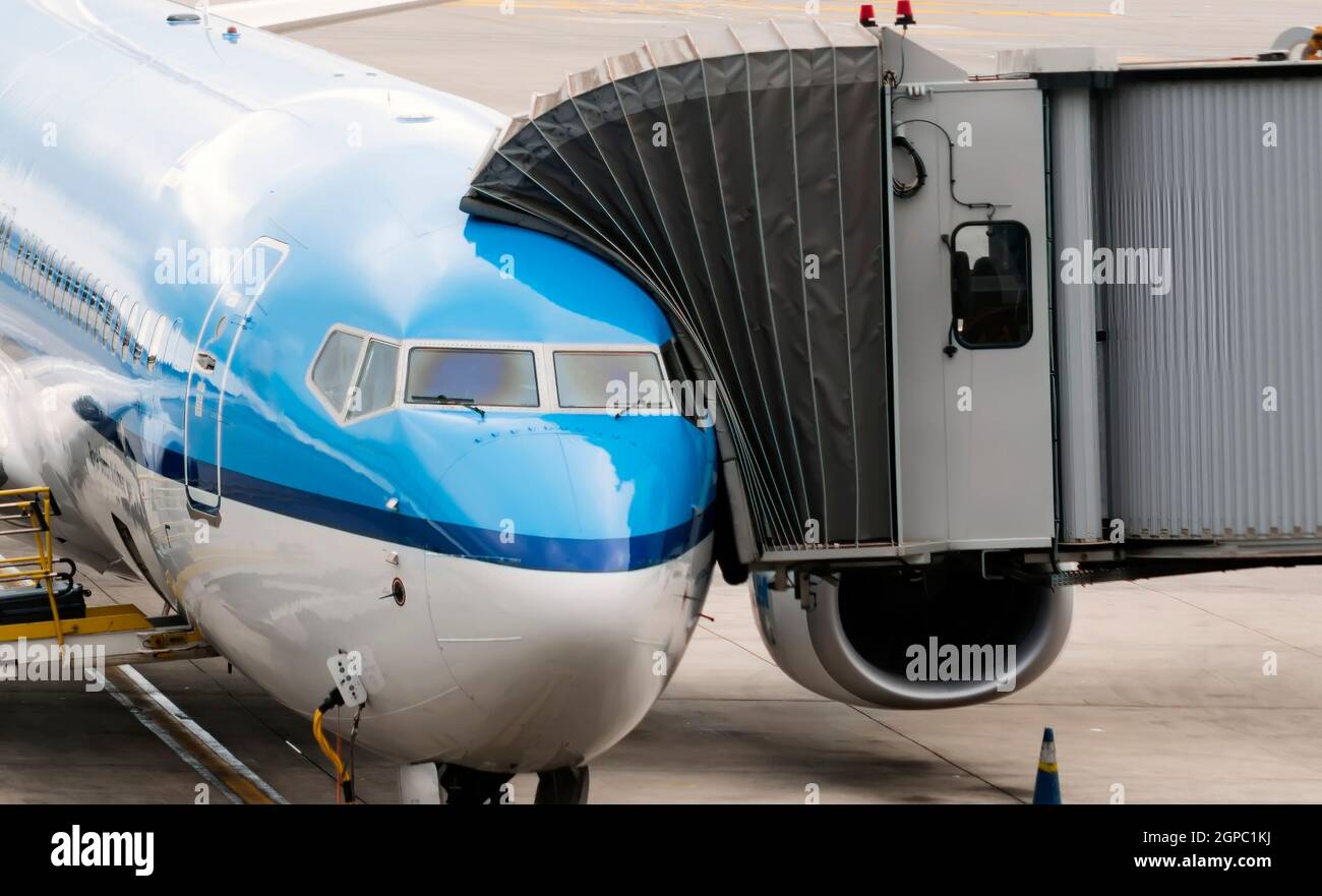 jet bridge attached to the fuselage of a commercial aircraft to allow ...