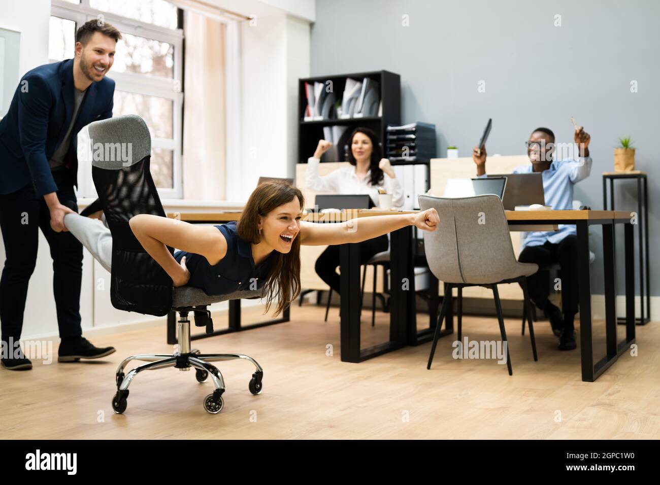 Business People Celebrate With Super Hero Fun Ride In Office Stock ...
