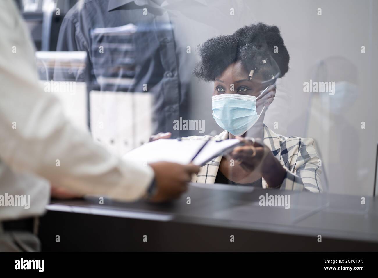 Hotel Reception Desk Protected By Medical Mask Stock Photo - Alamy