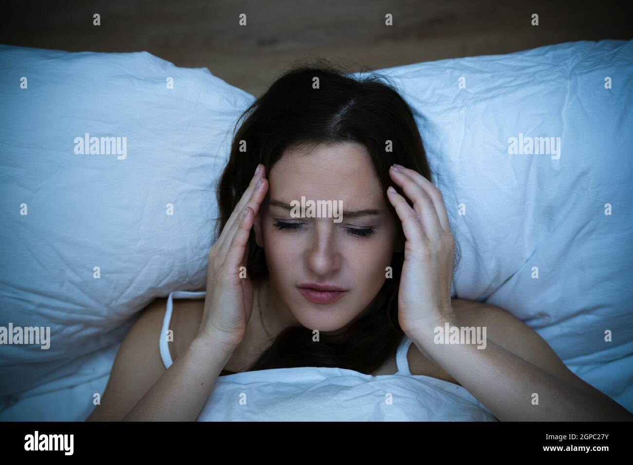 Stressed Woman With Headache Sleeping In Bed With Insomnia Stock Photo ...