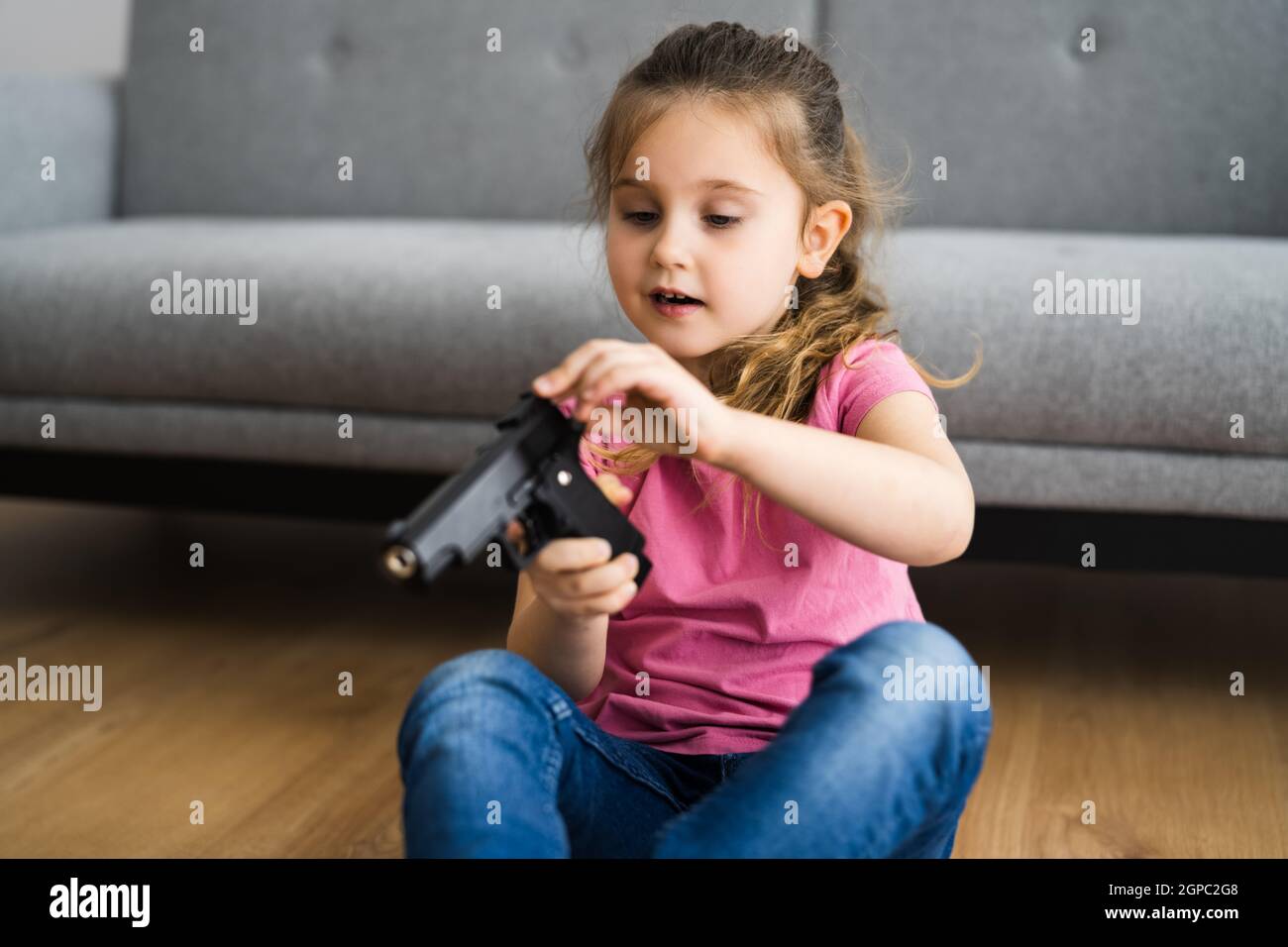 Child Girl With Gun. Kid And Children Safety Stock Photo - Alamy