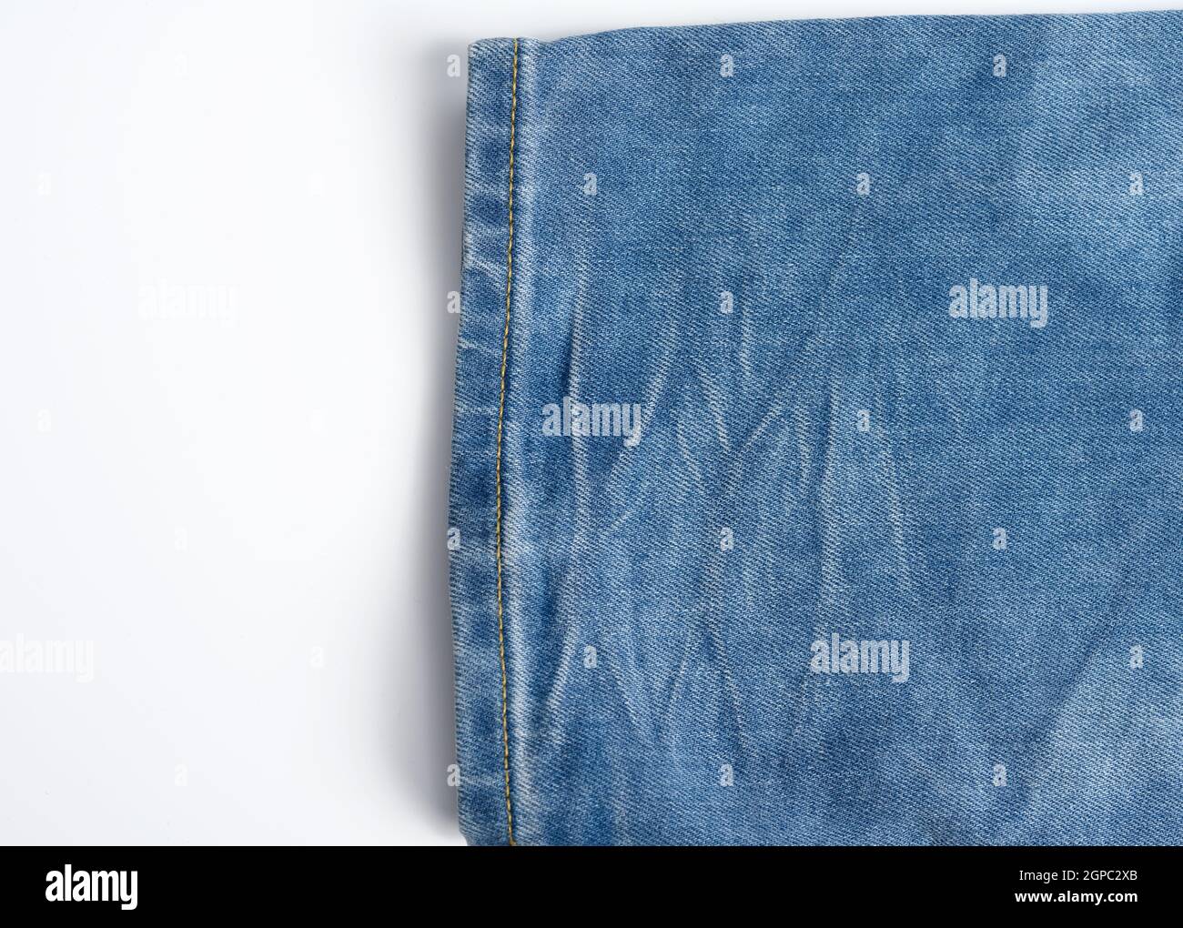 bottom seam on blue denim leg, white background, close up Stock Photo ...