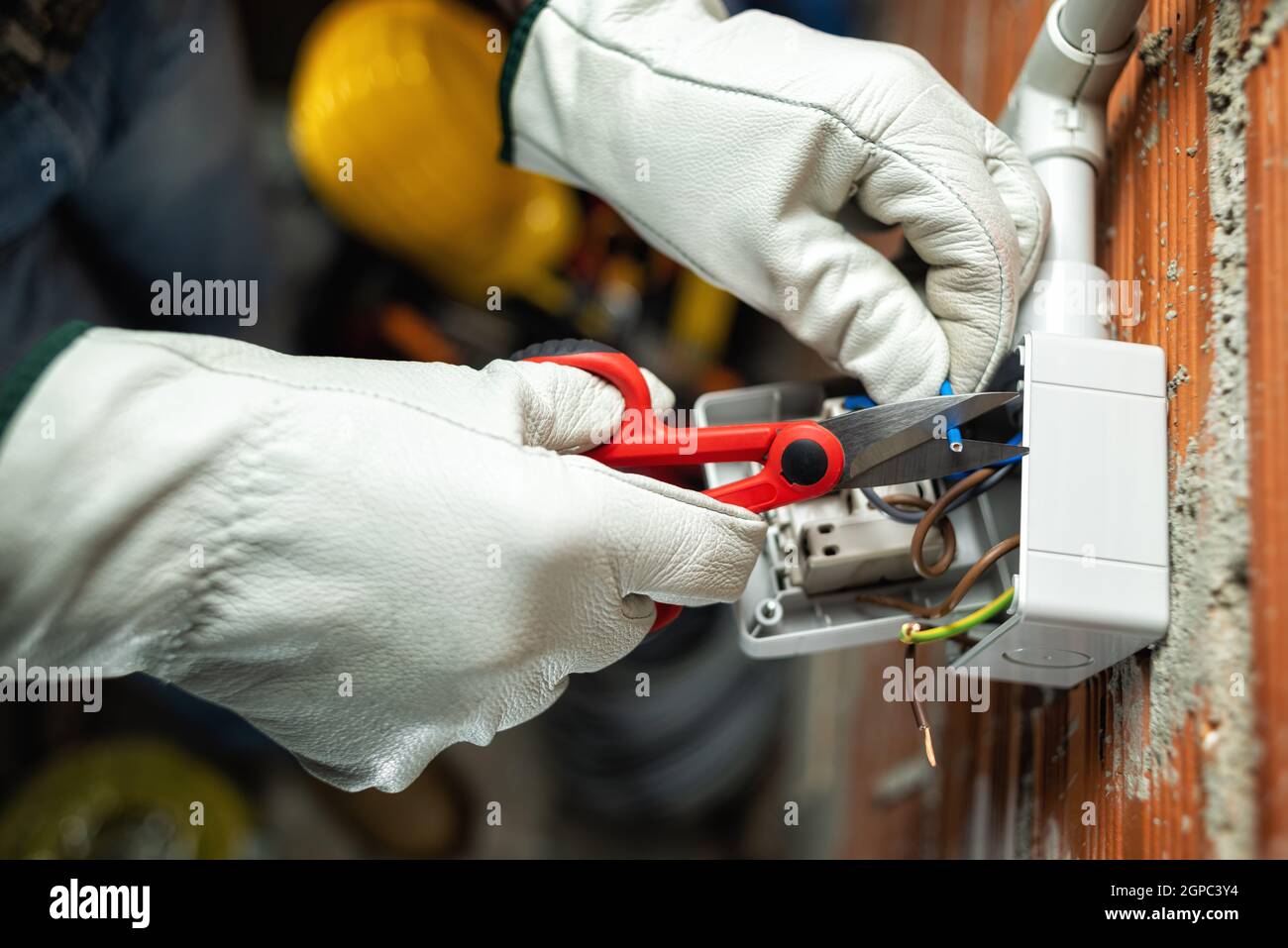 View from above. Electrician worker at work with scissors prepares ...