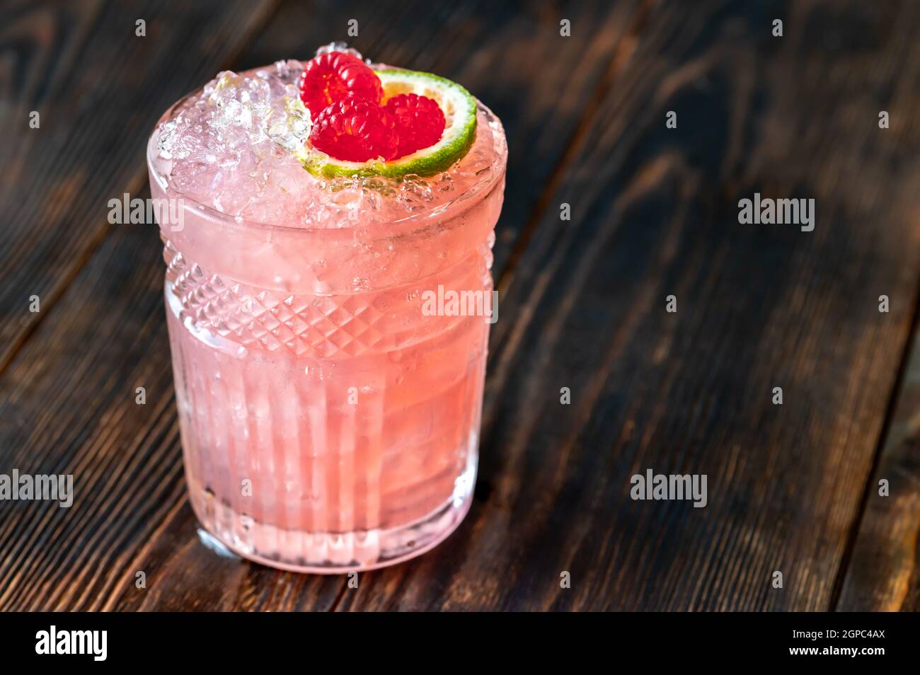 Glass of Knickerbocker cocktail made of rum, lime juice, orange curacao and raspberry syrup ...