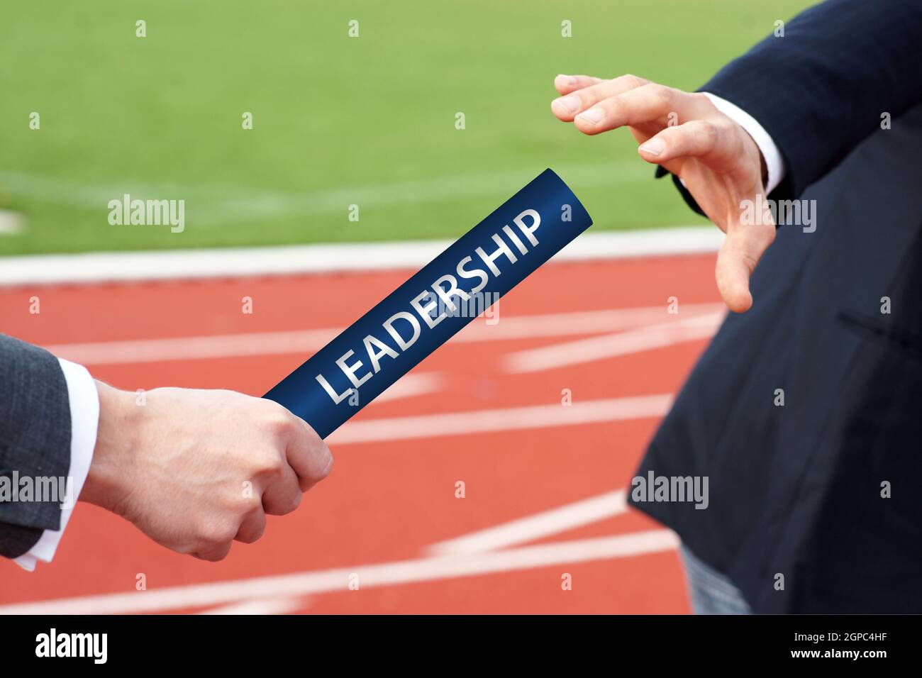Businessmen passes Leadership baton in stadium relay race Stock Photo ...