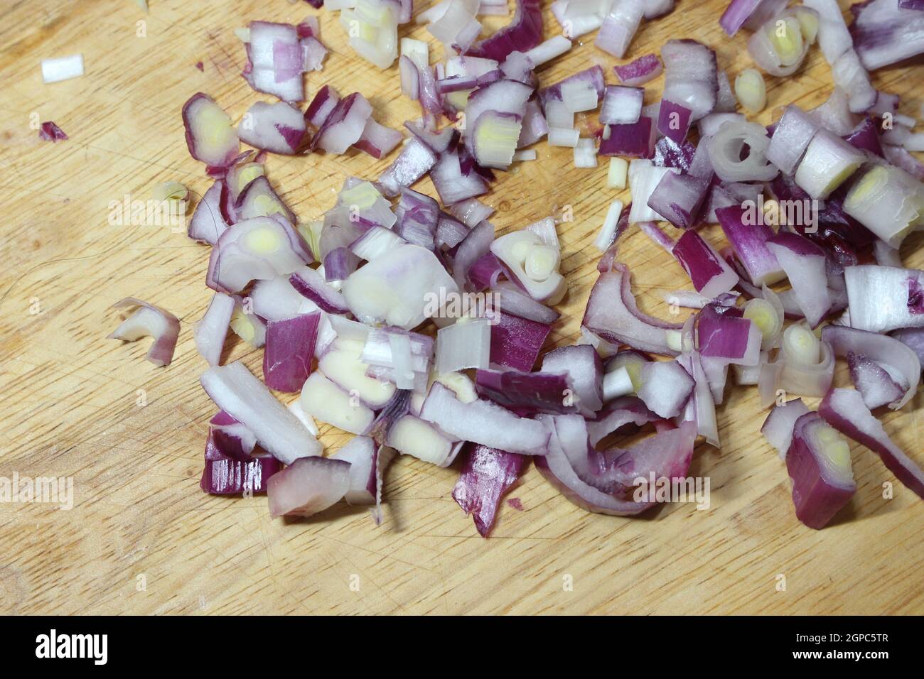 Chopped white onion with sharp knife on wooden cutting board. High ...