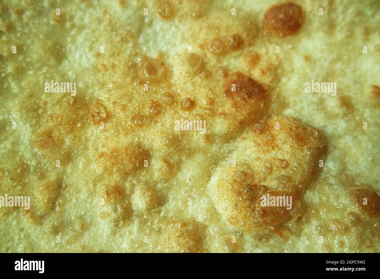 Closeup view of hand made plain bread in oil called paratha roti ...