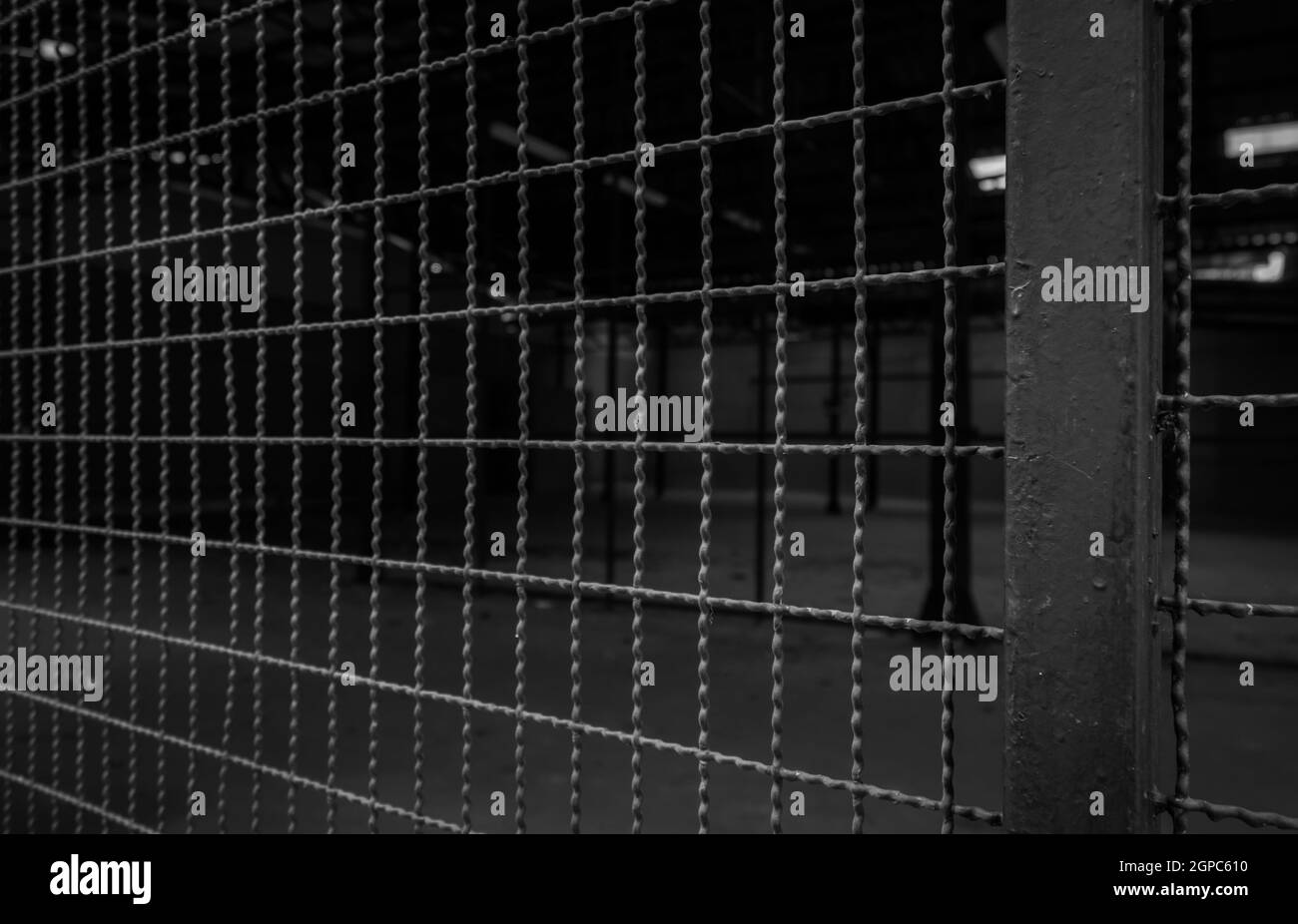 Metal wire fence of empty warehouse. Dark background of private area ...