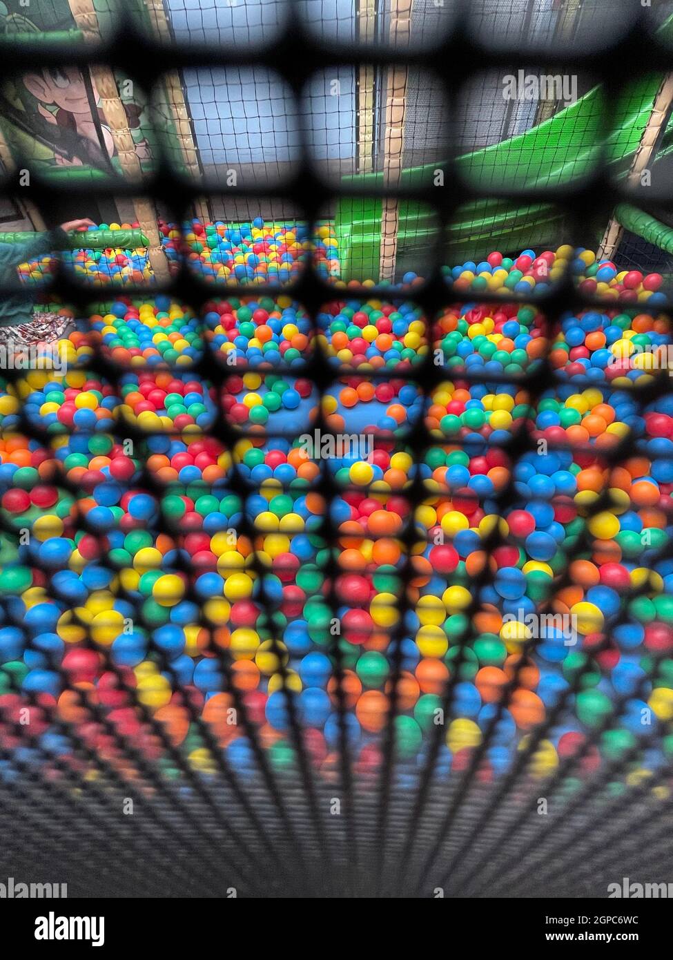 Vertical shot of a playing area with slides and multicolor small balls ...