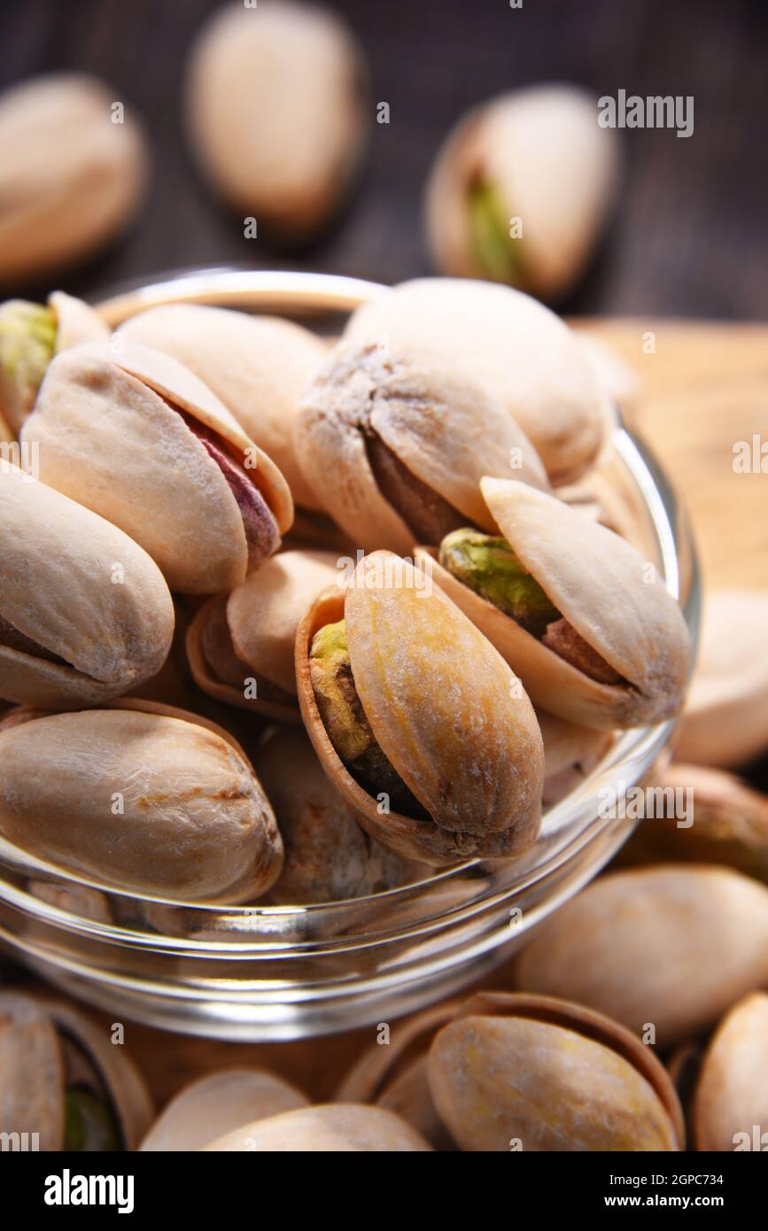 Composition with bowl of in shell pistachios. Delicacies Stock Photo ...