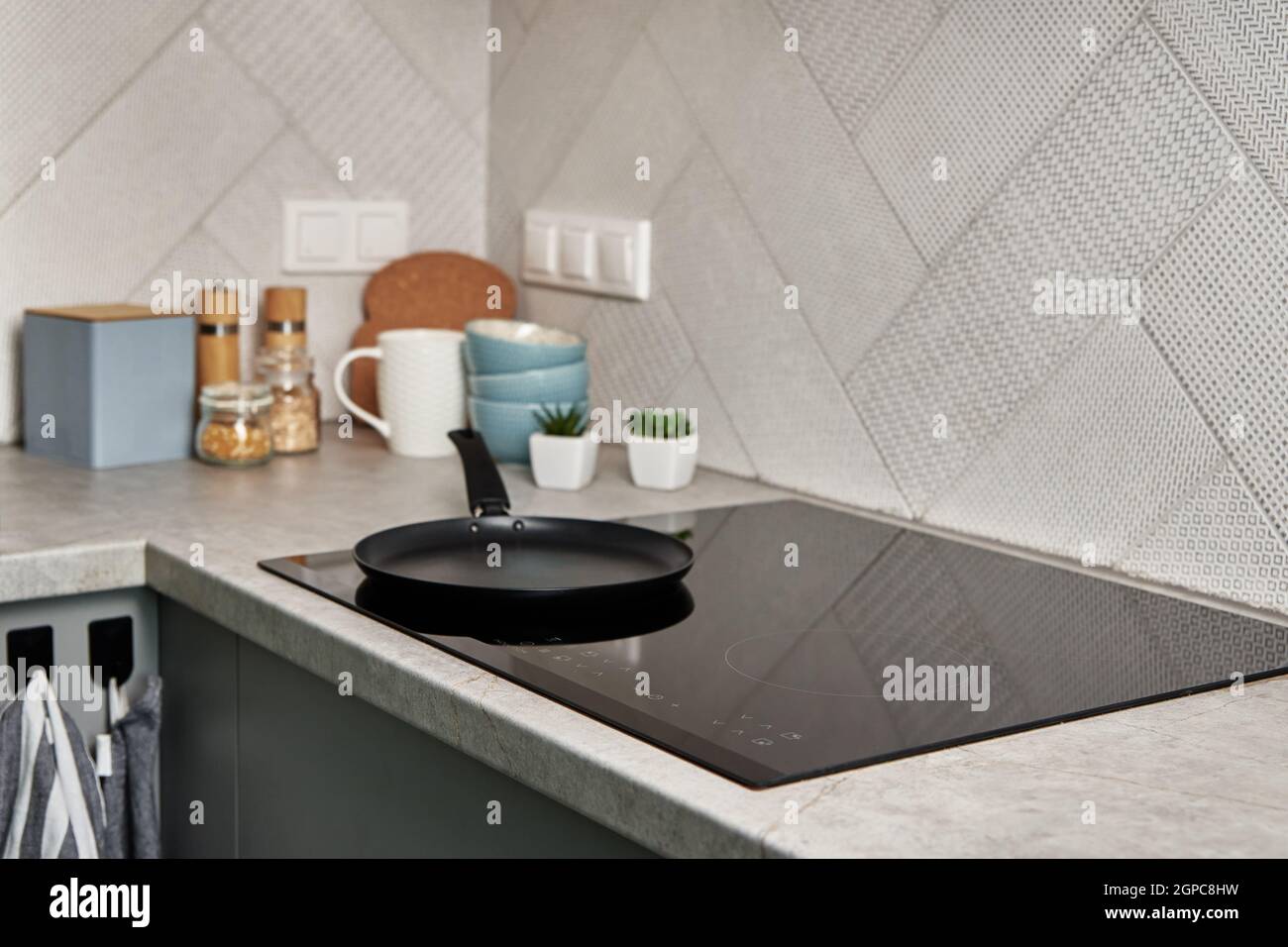 Modern kitchen appliance. Cooking pan on the surface of induction panel ...