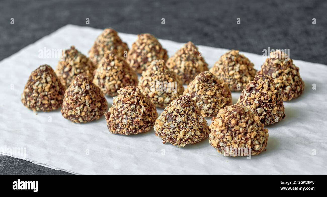 Chocolate cone-shaped truffles sprinkled with waffle crumbs close-up ...