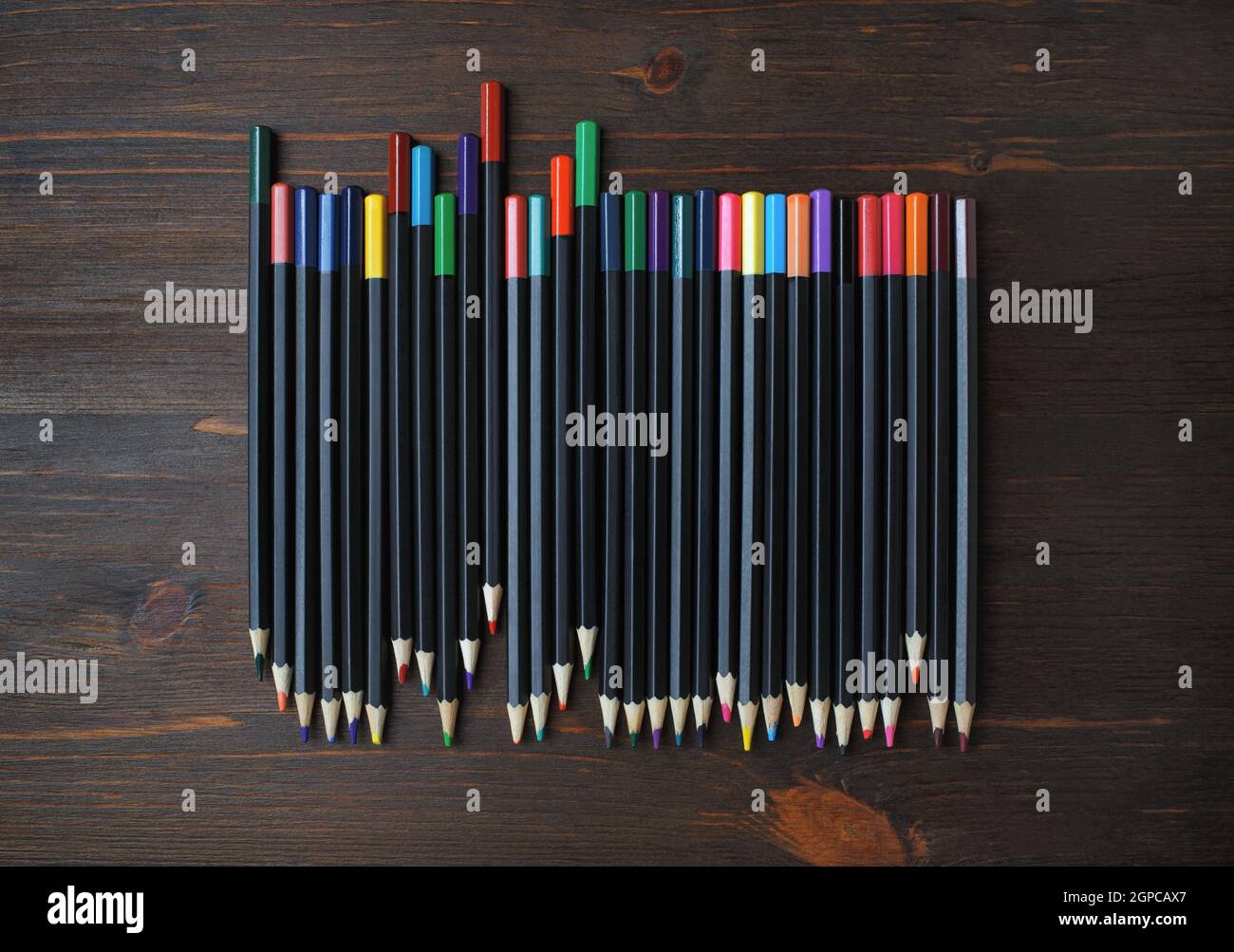 Color pencils on wood table background. Beautiful color pencils. Flat ...
