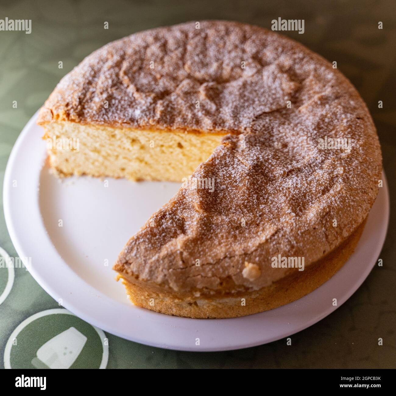 Aerial view of an incomplete santiago cake with one slice missing on a ...