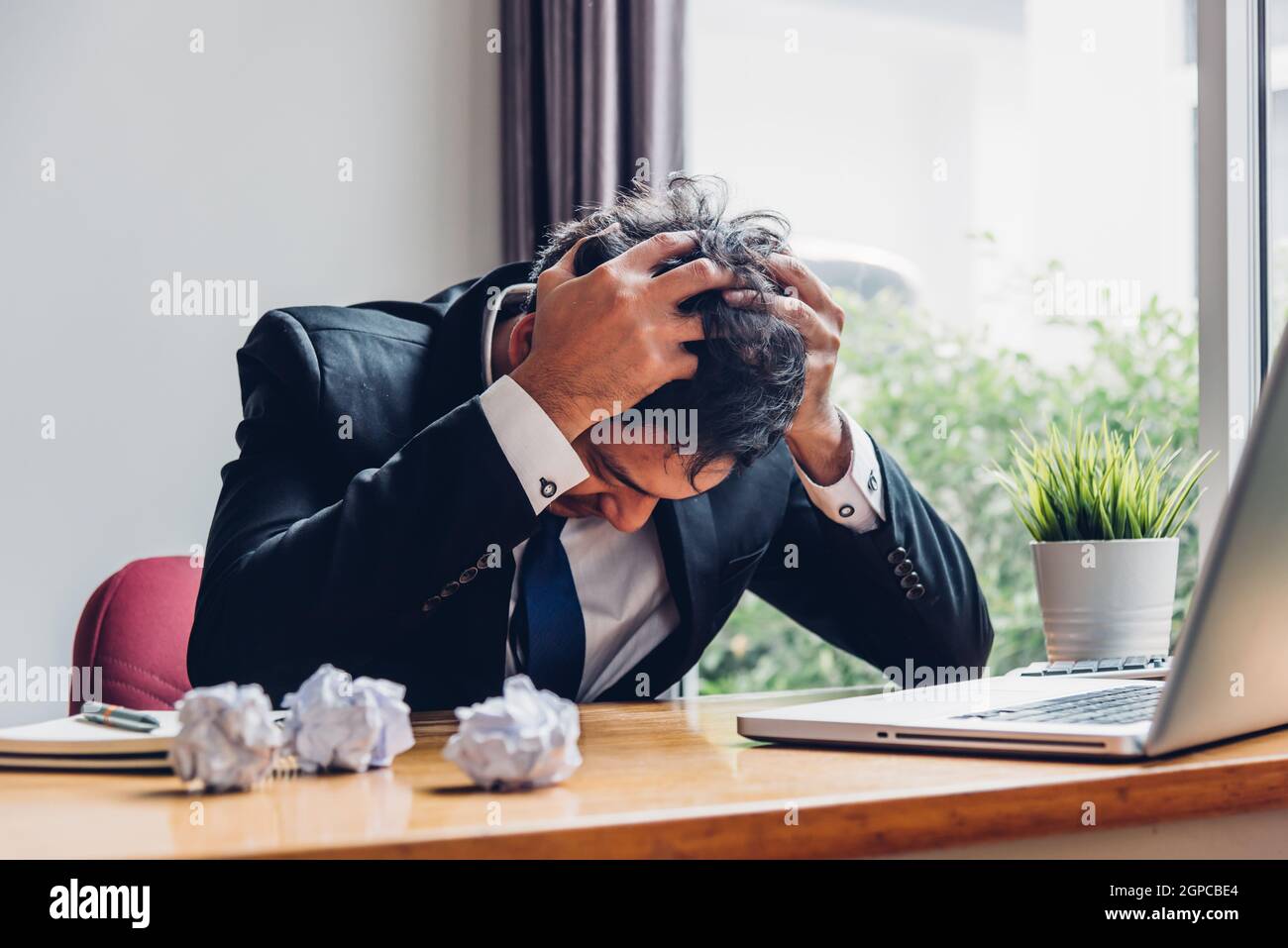 Asian young business man tired strain failure on he work in desk table ...