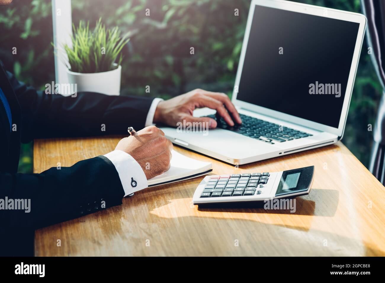 Business man accounting using calculating and work with laptop computer ...