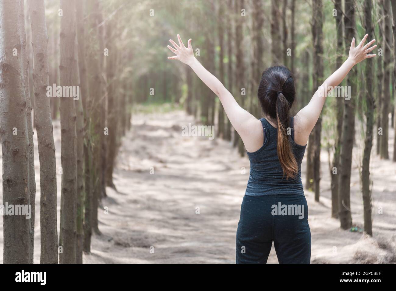 Beautiful young woman lifestyle fresh air happy relaxing in forest park ...