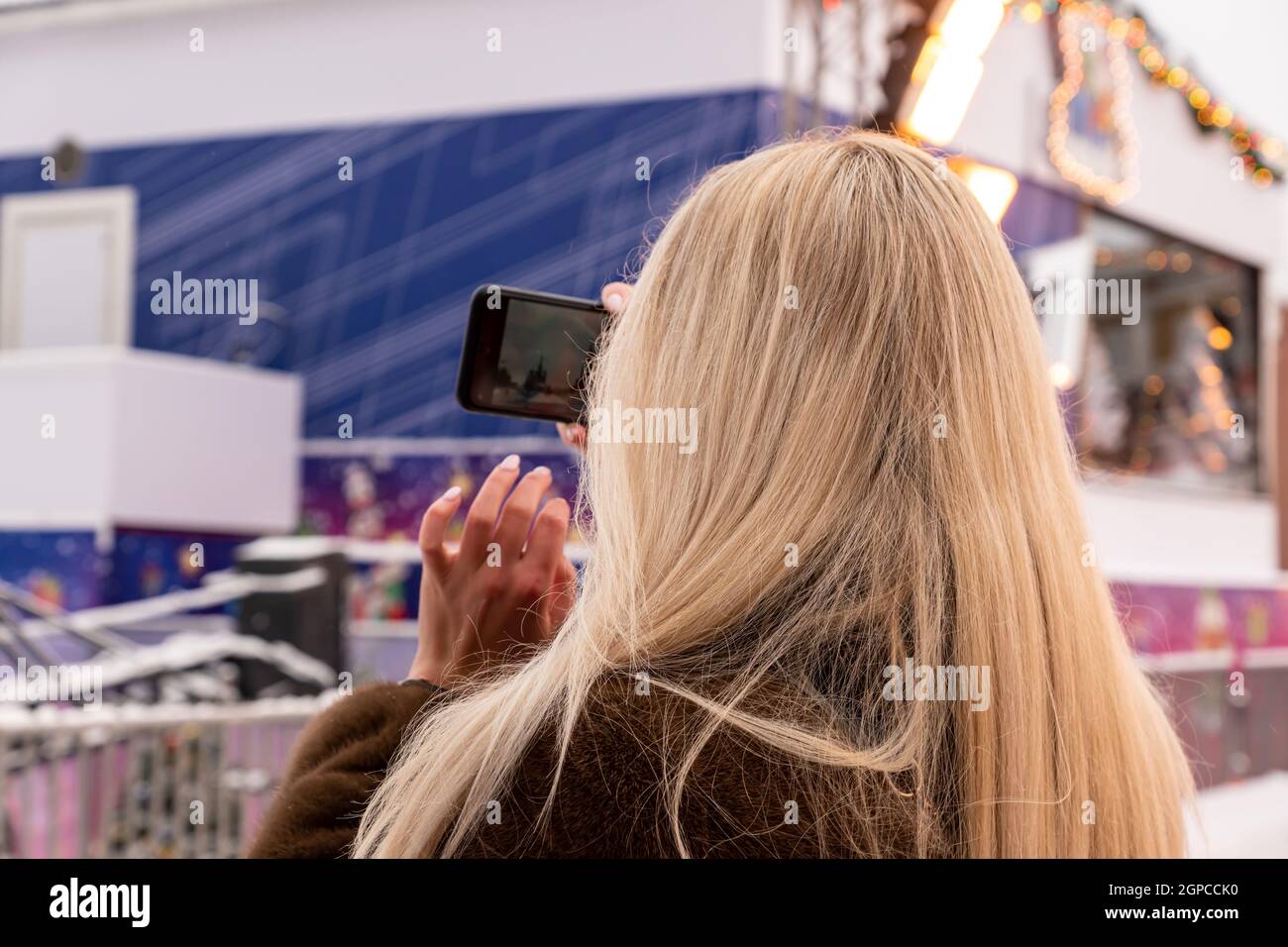 MOSCOW, RUSSIA - DECEMBER 15, 2020: A blond hair woman takes a picture ...