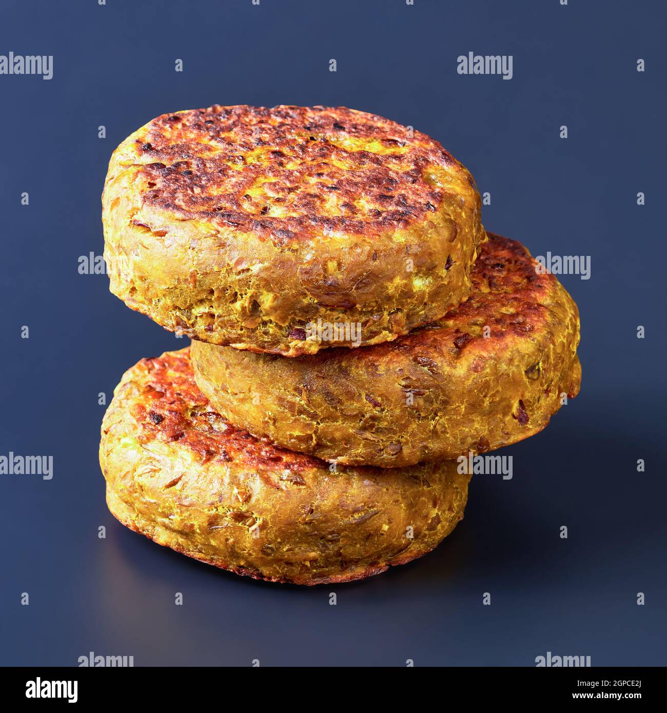 three vegan lentil and bean burgers, patties on black background, close ...
