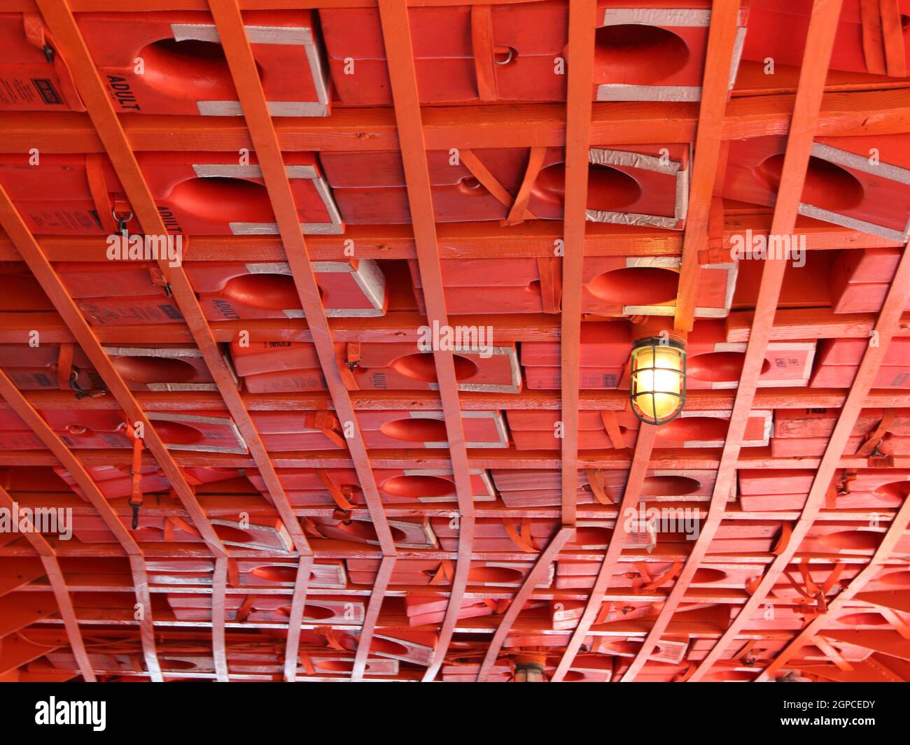 Red Life Jackets mounted in Ceiling of Boat Stock Photo - Alamy