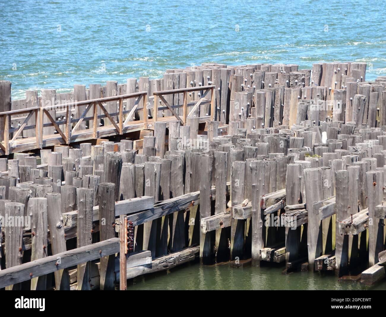 Strong Wooden Pier with Large Silver Timber Poles Stock Photo - Alamy
