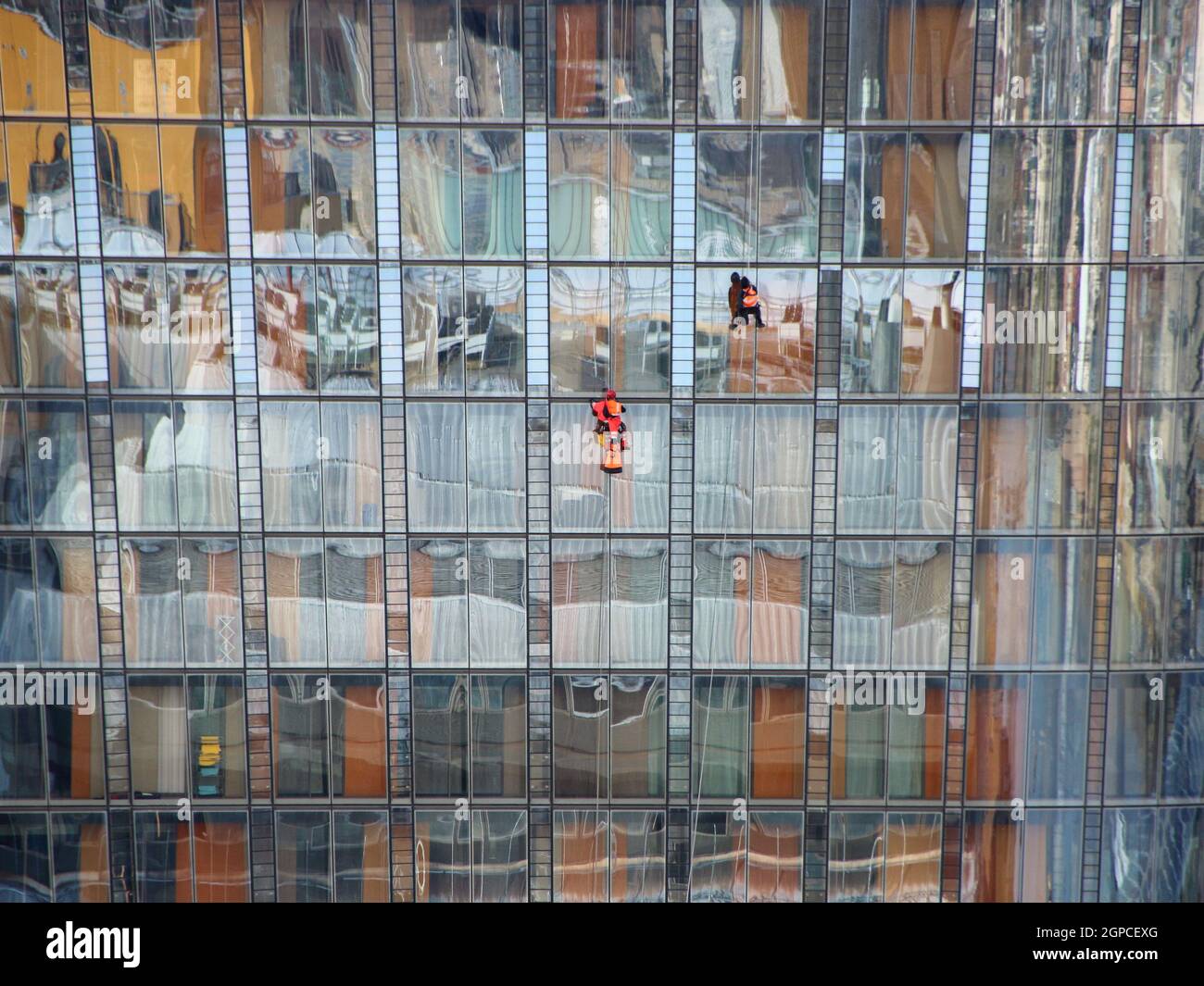 Two Window Construction Workers on Skyscraper with Colorful Reflection ...