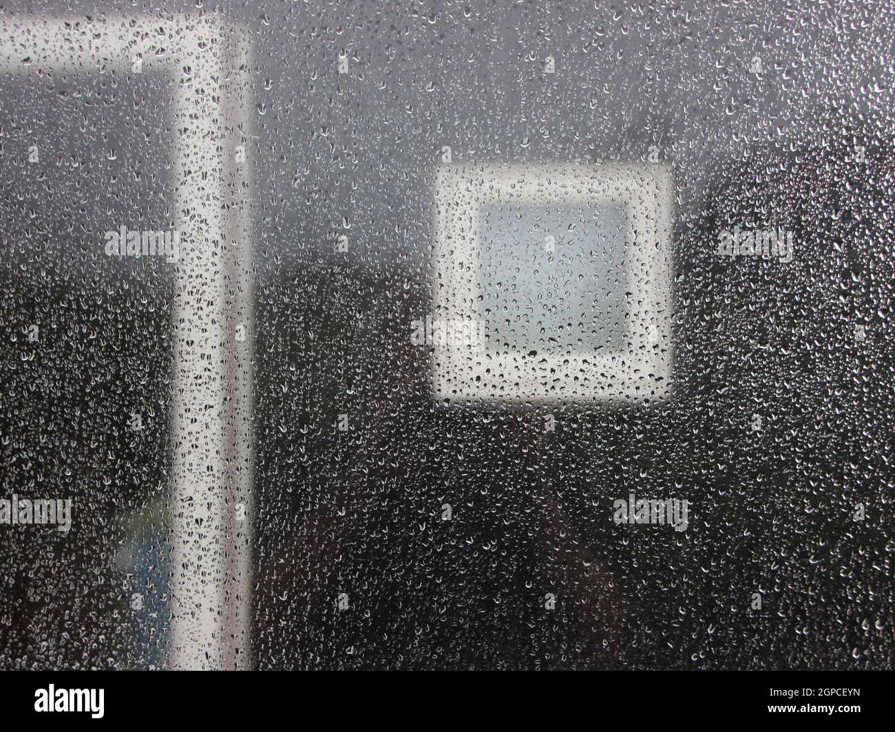 Raindrops on Window Glass with Dark Black Wooden House Facade ...