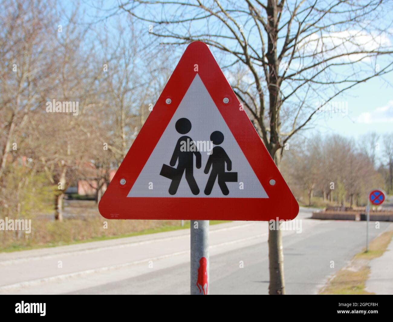 A triangle road sign telling drivers to be cautious of school children ...