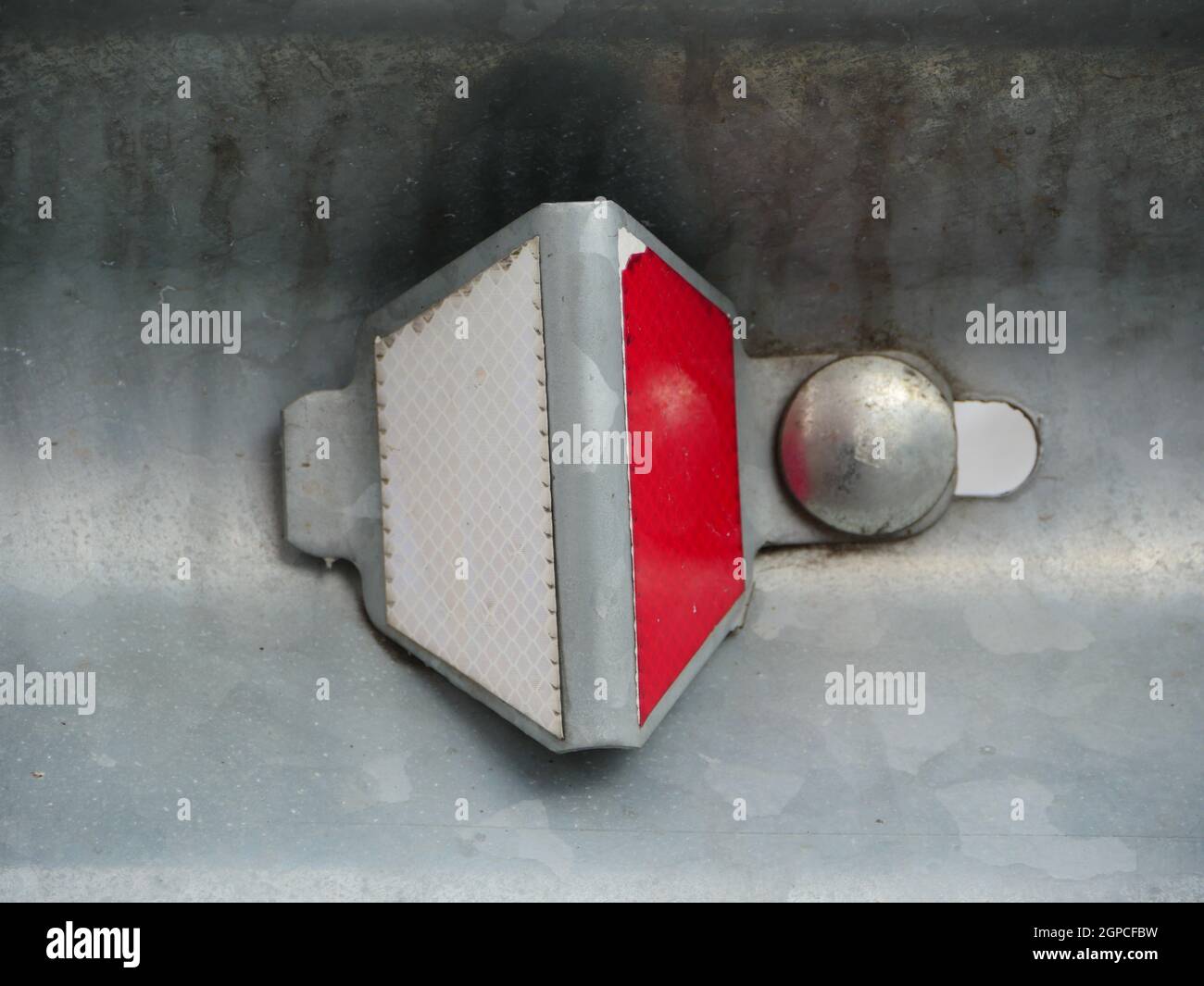 road reflector red and white retro-reflective optical unit close-up ...