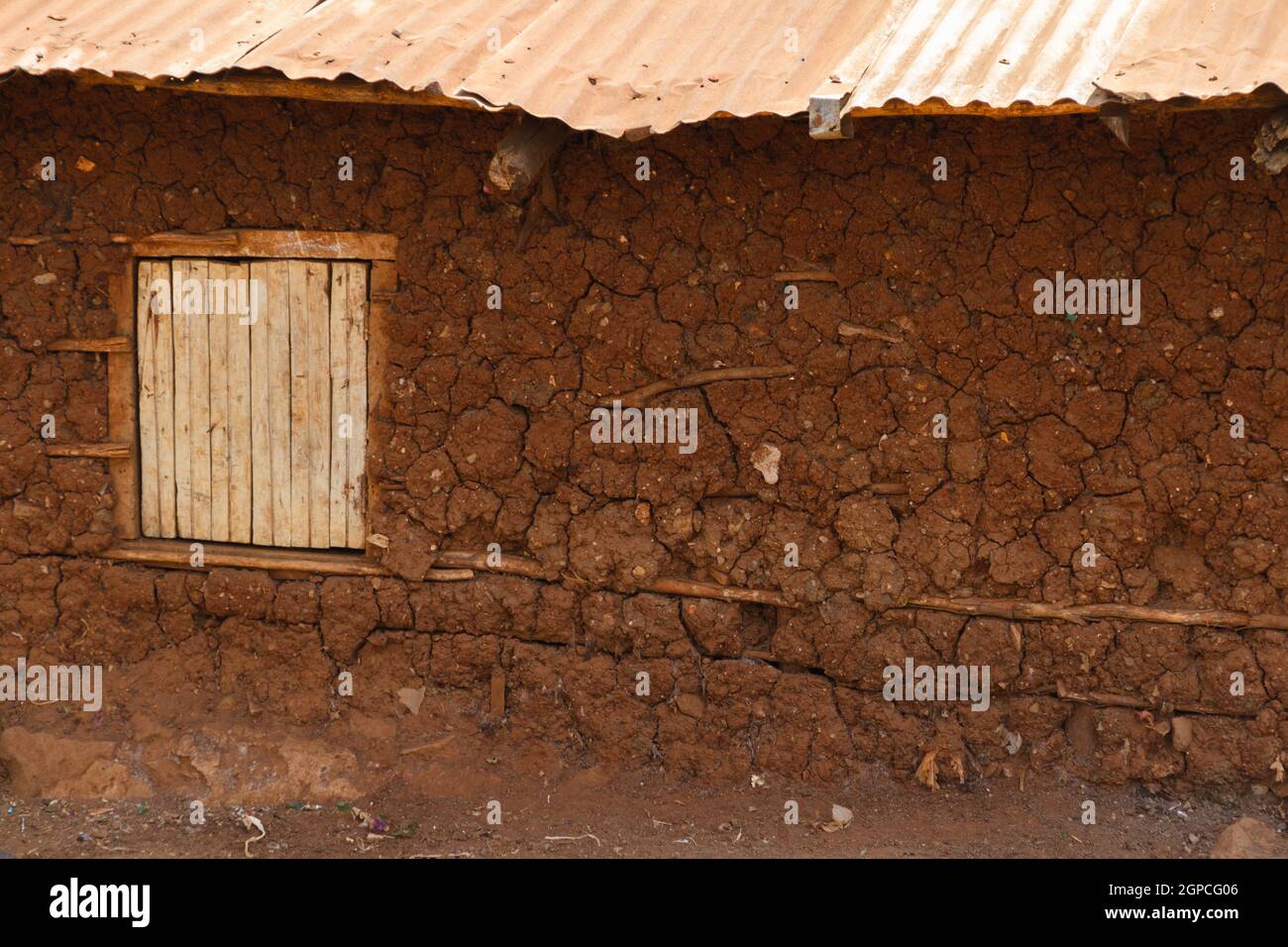 A mud hut home with a window inside the Kibera slum of Nairobi, Kenya ...