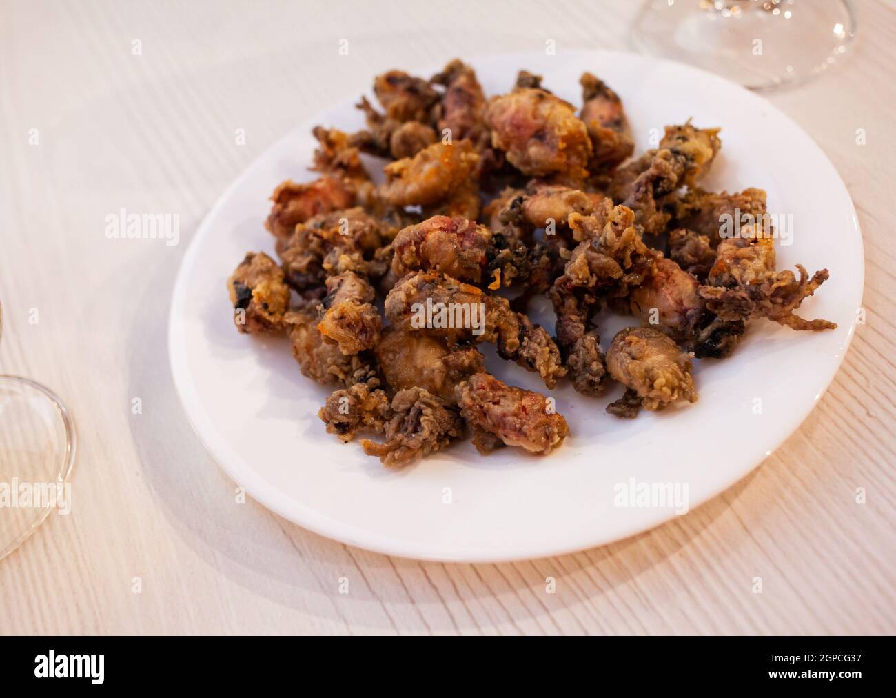 Chipirones, breaded fried calamari with lemon Stock Photo - Alamy