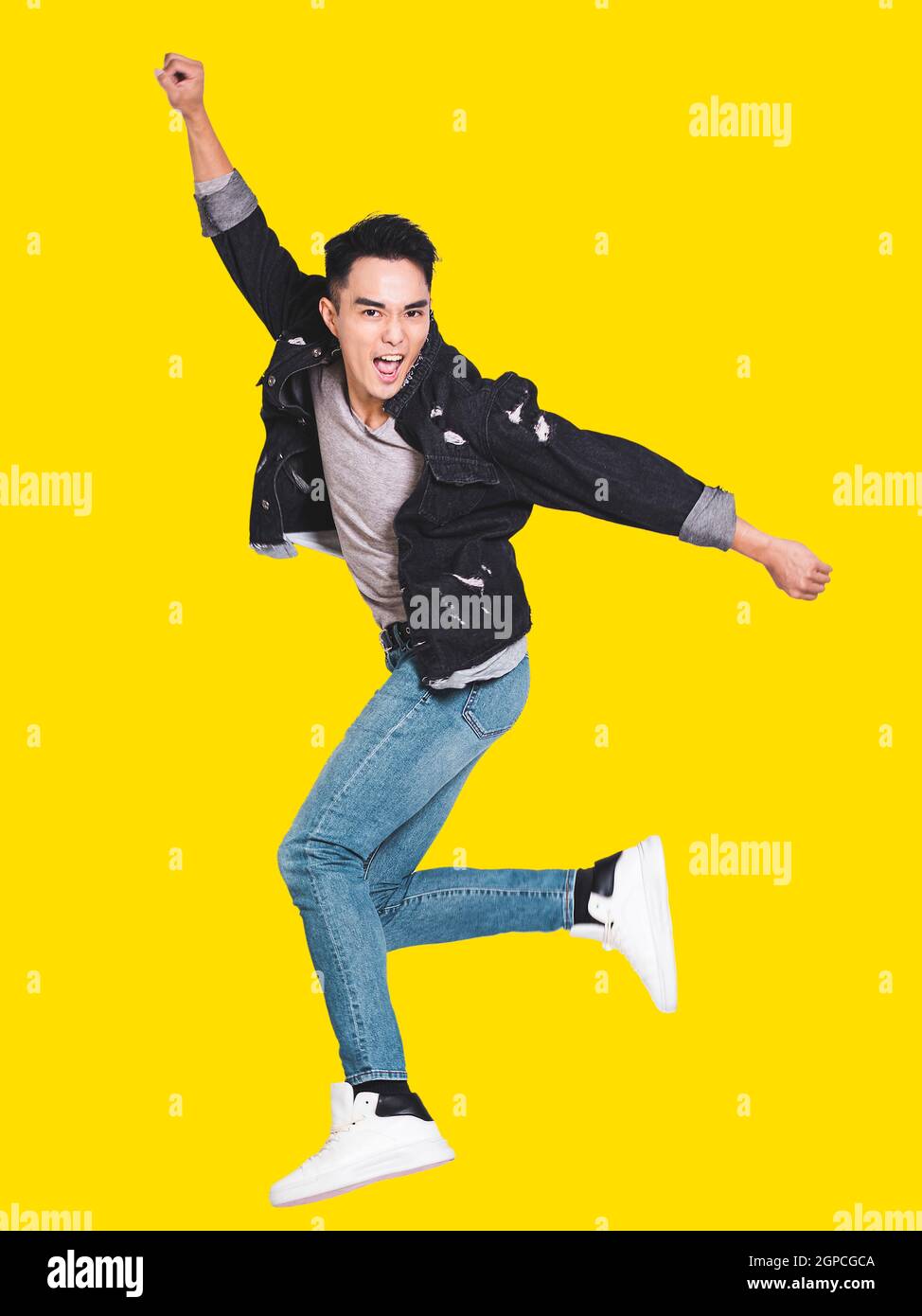 Excited handsome young man in casual clothes jumping and dancing Stock ...