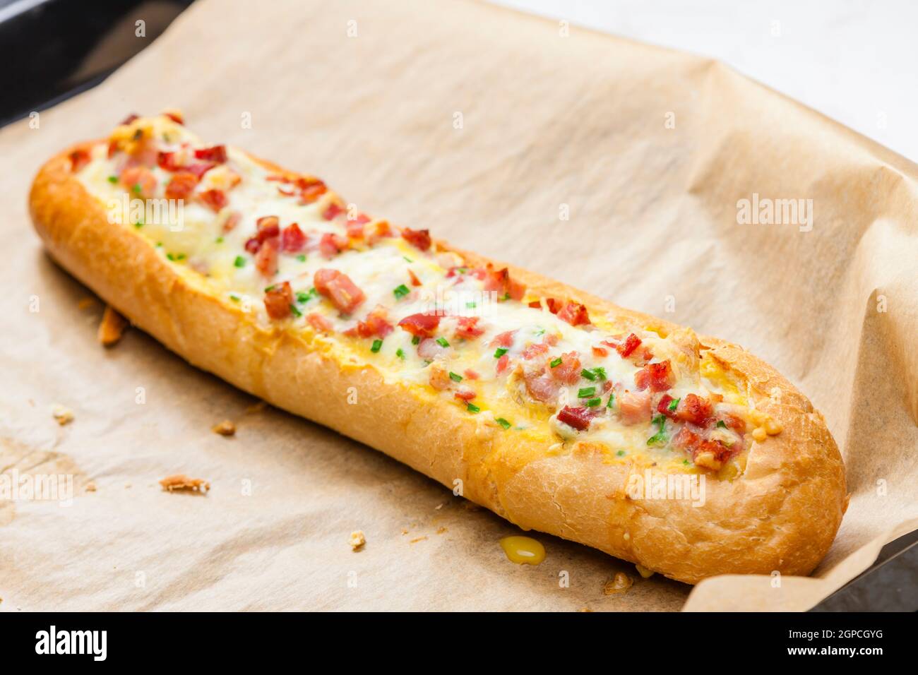 baked baguette filled with cheese and ham Stock Photo - Alamy
