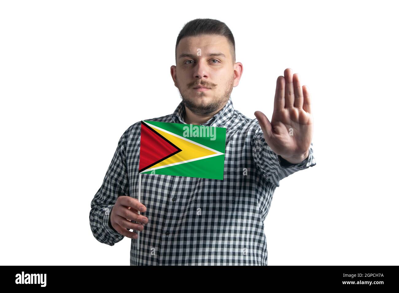 White guy holding a flag of Guyana and with a serious face shows a hand ...