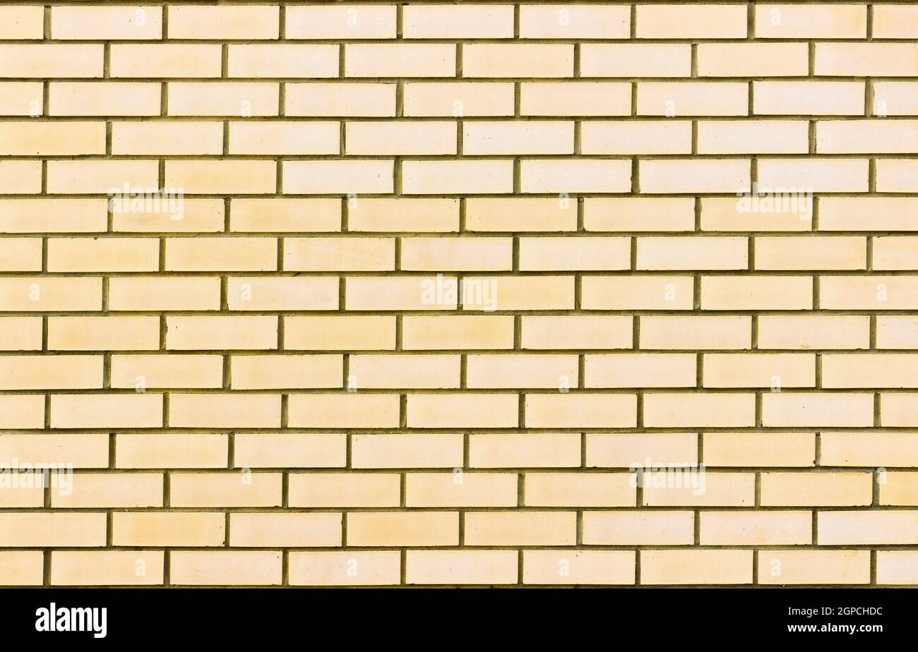 Photograph of a brick wall pattern. The bricks are light yellow in ...