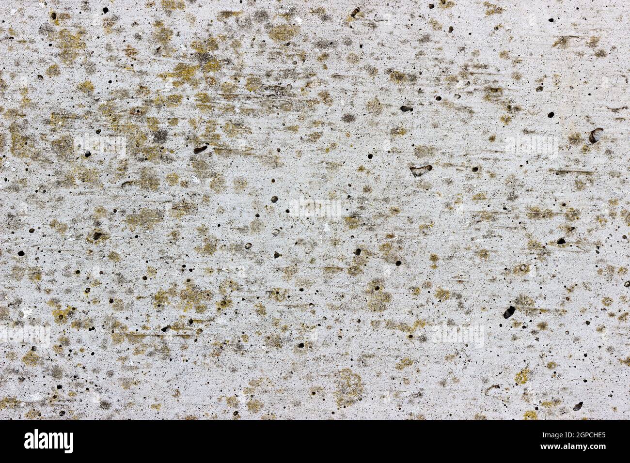 A flat grey concrete surface. The surface is textured and covered in ...