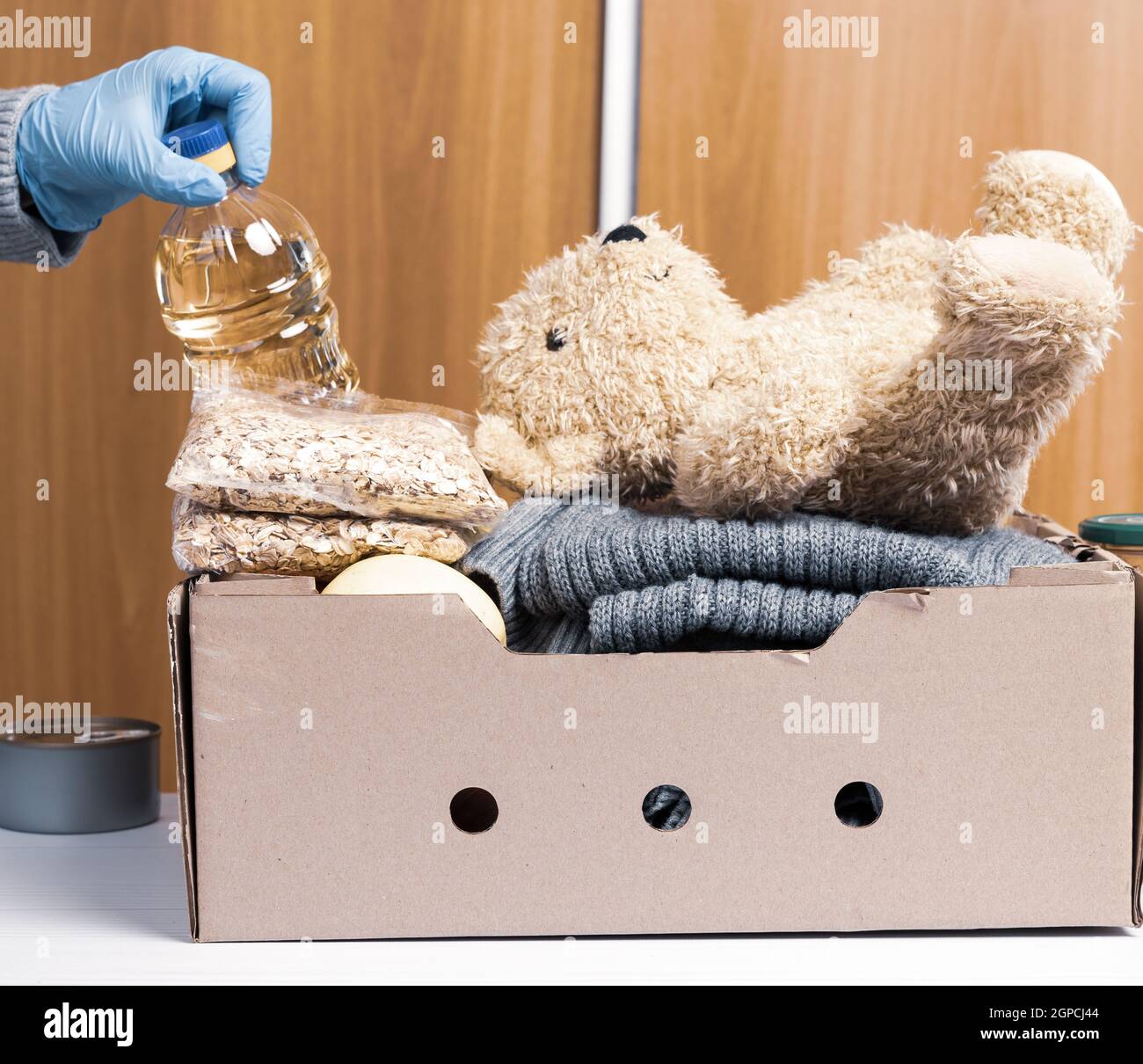 cardboard box with food and things to help those in need, help concept ...