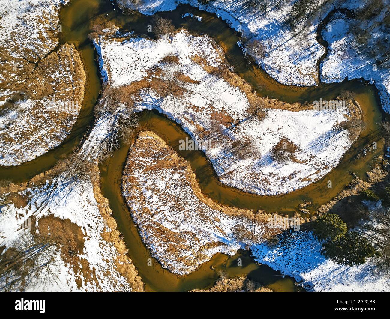 Early spring landscape with melting snow and meadow. Top aerial view ...